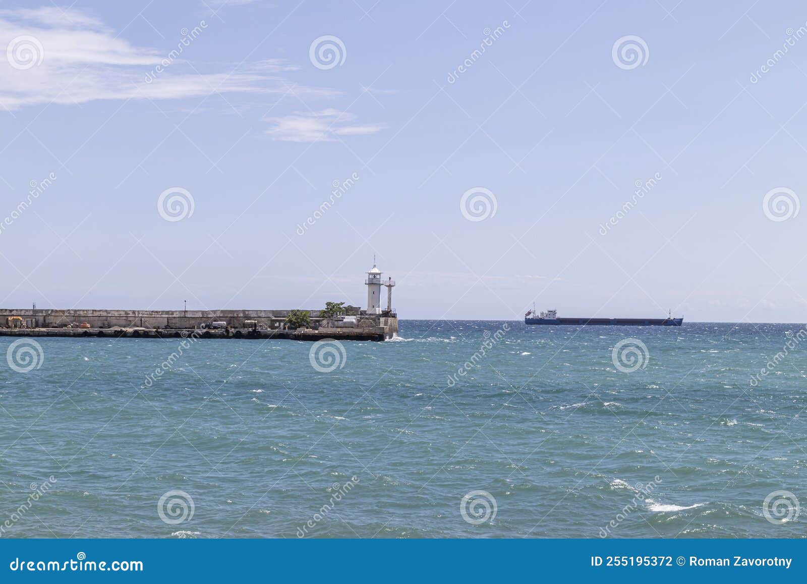 Lighthouse on the Pier and Cargo Ship Stock Photo - Image of pier ...