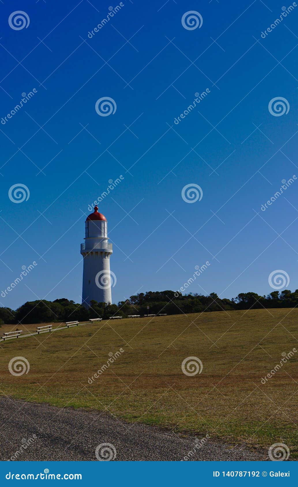 Lighthouse with red roof stock photo. Image of edge - 140787192