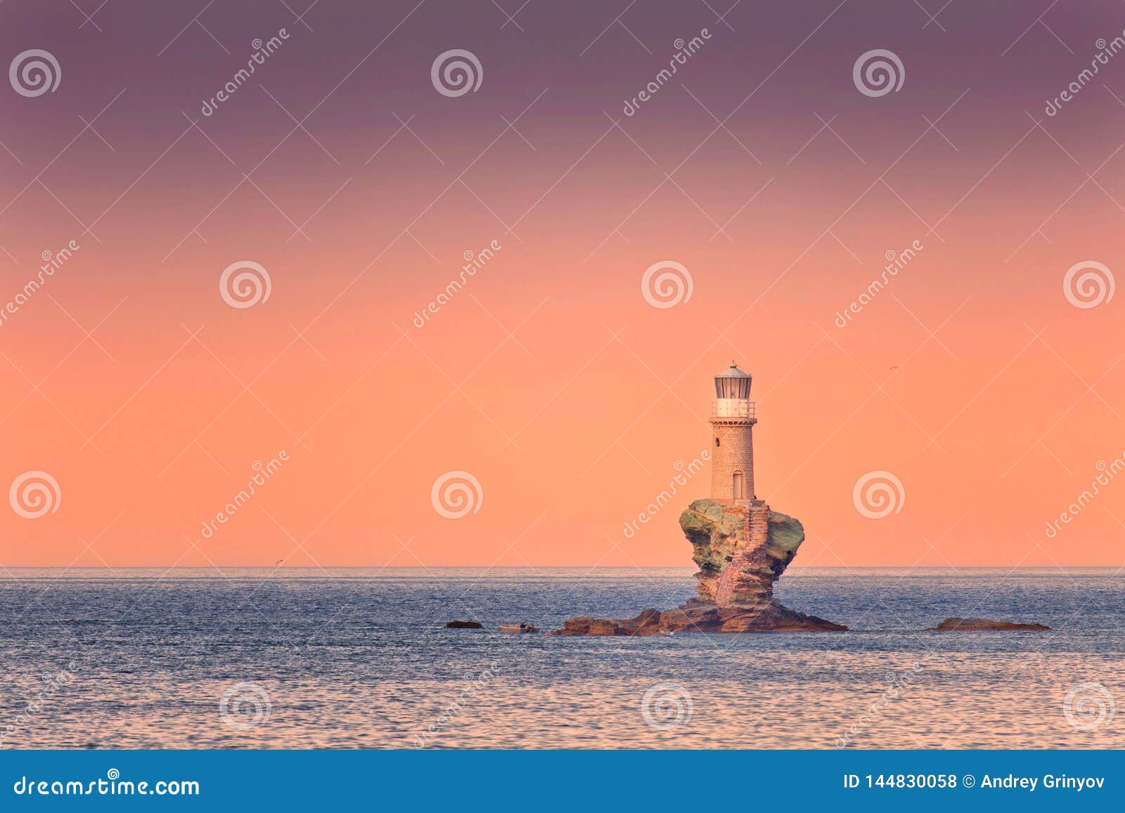 Lighthouse on the Rock at Sunset Stock Photo - Image of orange, summer ...