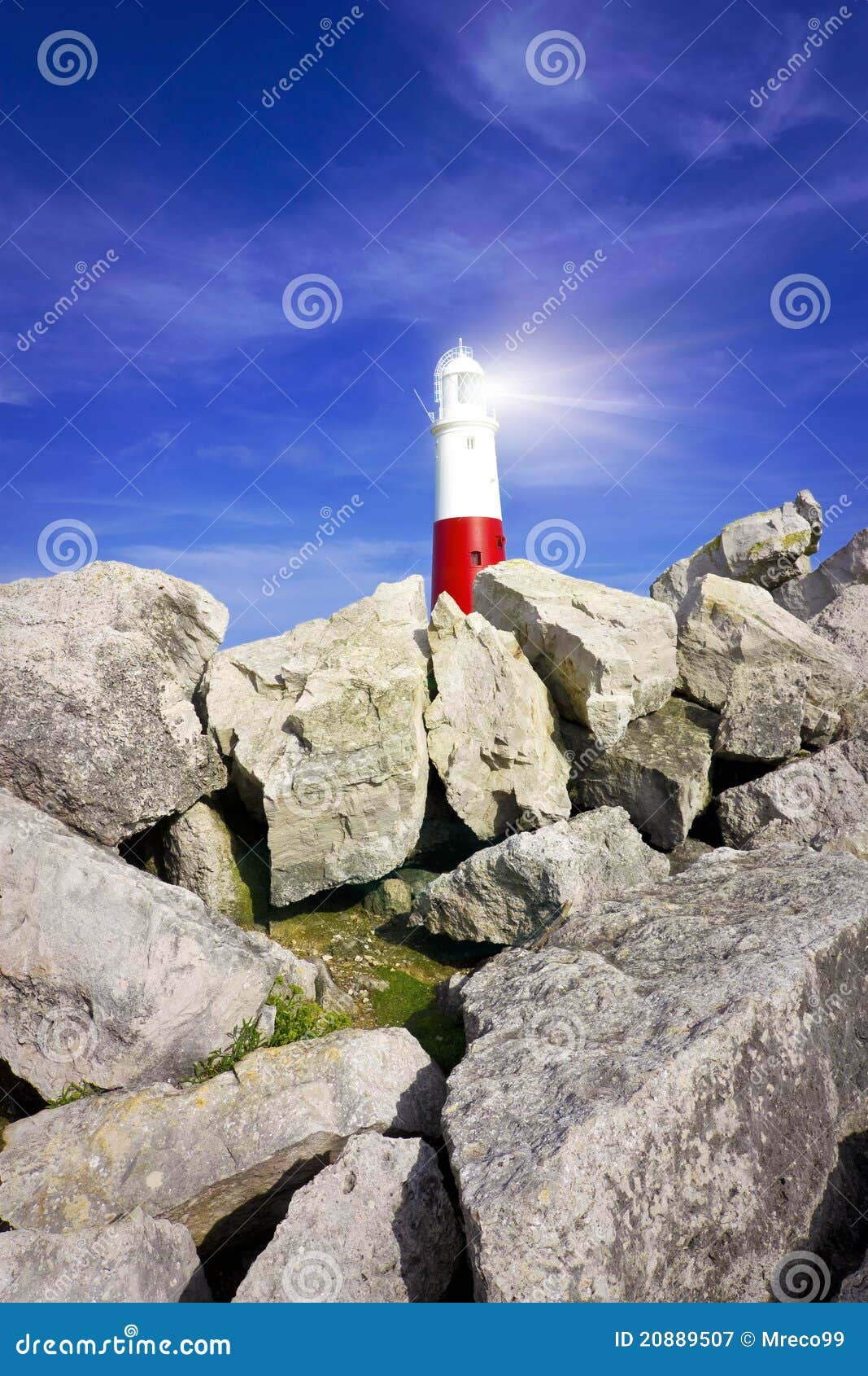 Lighthouse on Rocks with Light Beams Stock Image - Image of lamp, glow ...