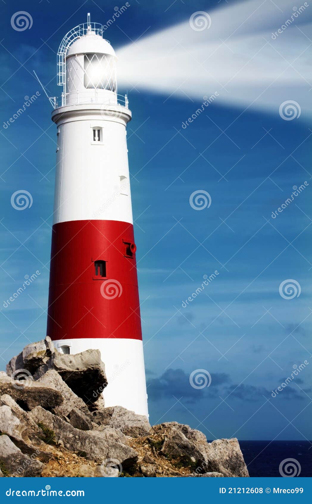 Lighthouse on Rocks with Light Beams Stock Photo - Image of lighting ...