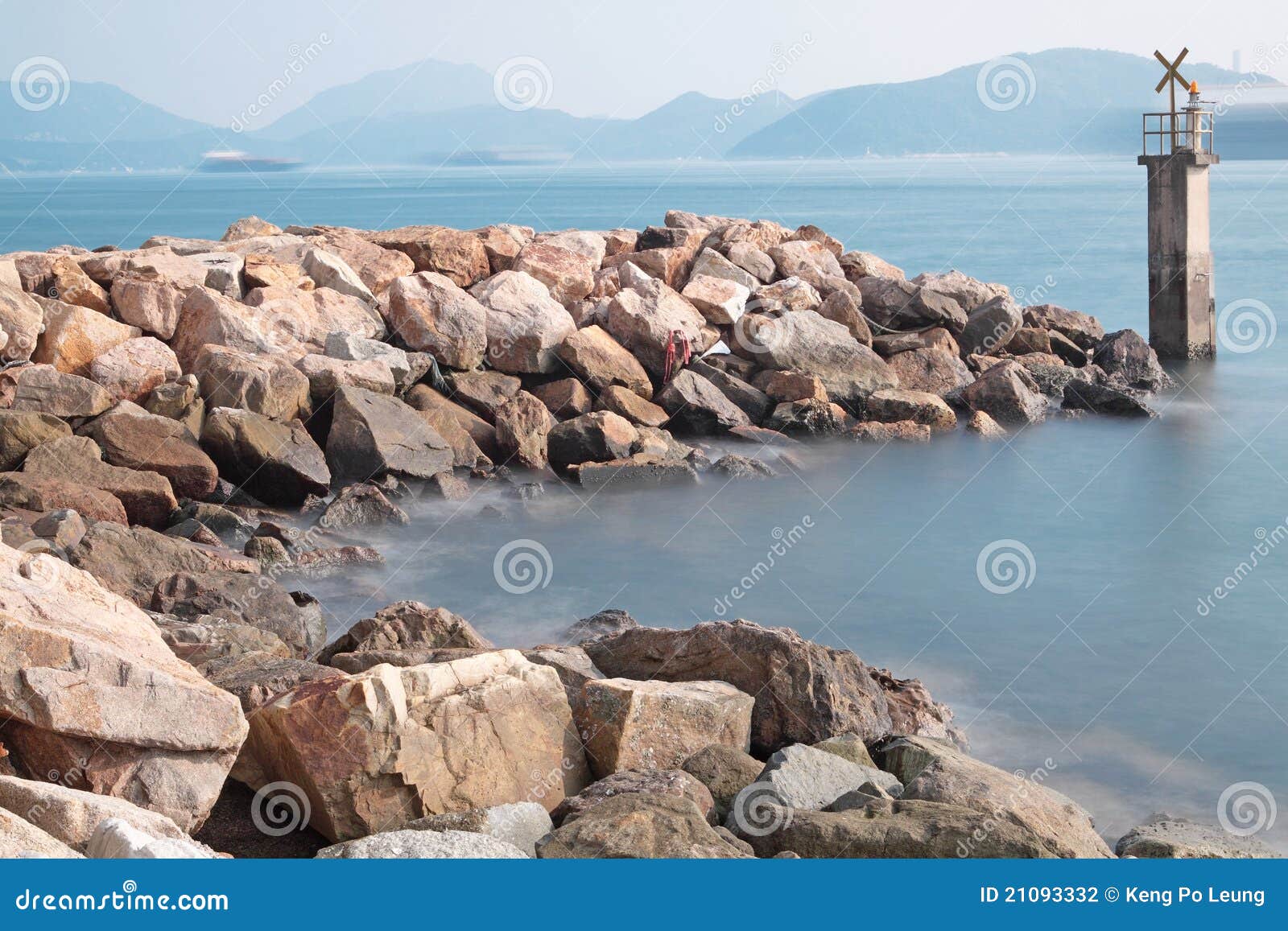 Lighthouse on a Rocky Breakwall Stock Photo - Image of coast, blue ...