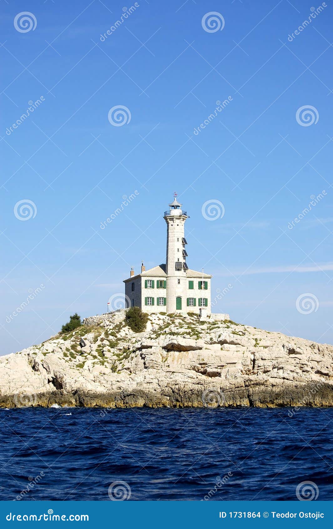 Lighthouse on rocky island stock photo. Image of croatia - 1731864