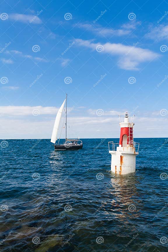 The Lighthouse and the Sail Stock Image - Image of sailing, horizon ...