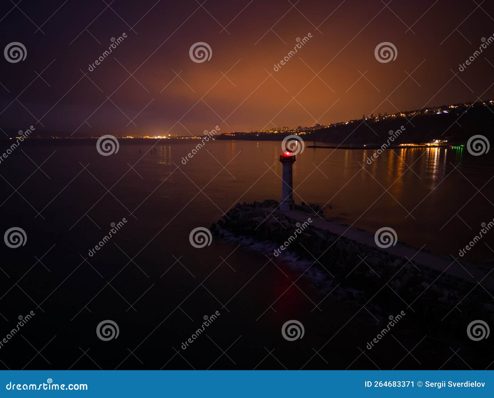 Lighthouse on the Seashore with Red Light at Night Against the ...