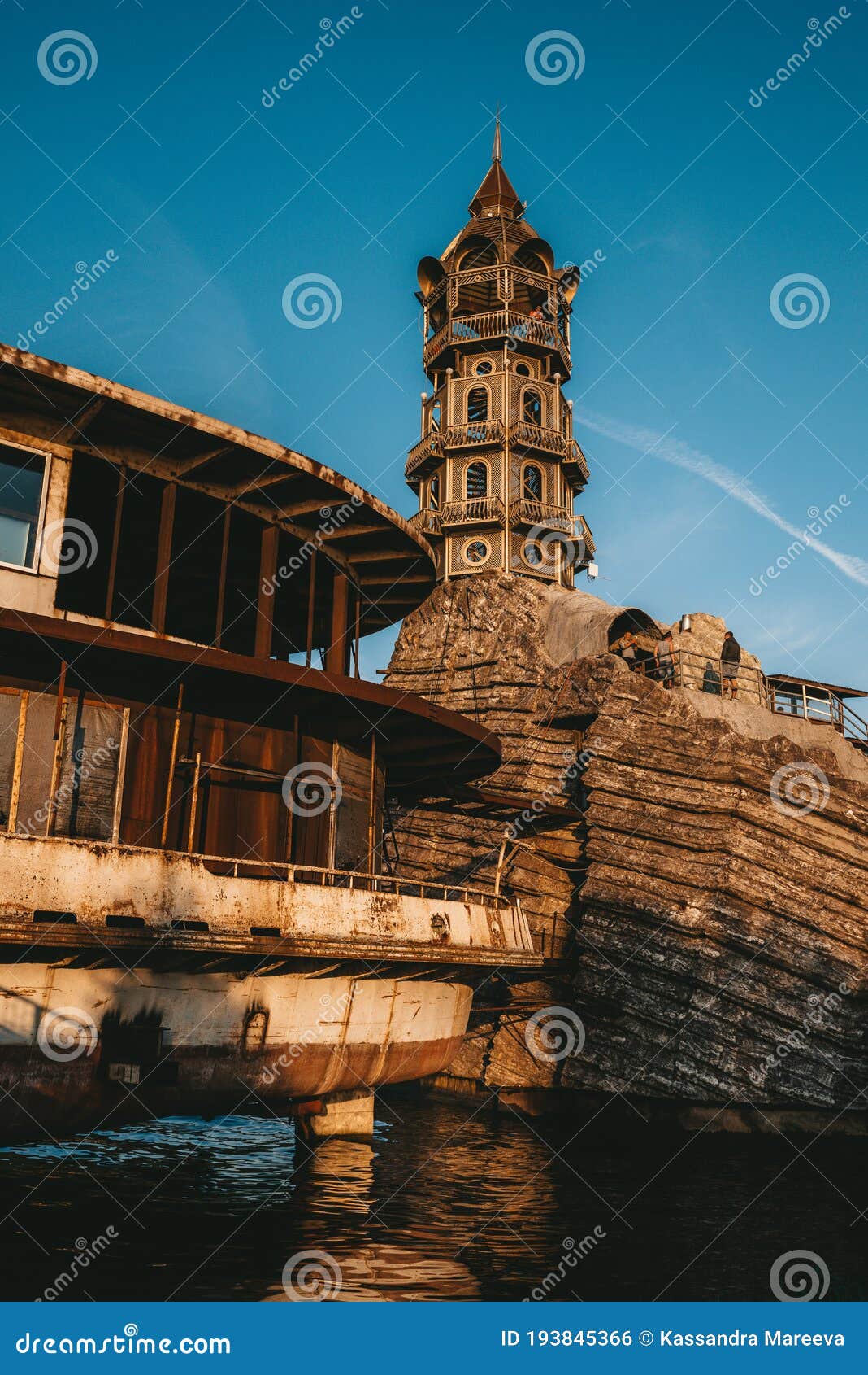 A Lighthouse in the Setting Sun. a Lighthouse and an Abandoned Ship in ...