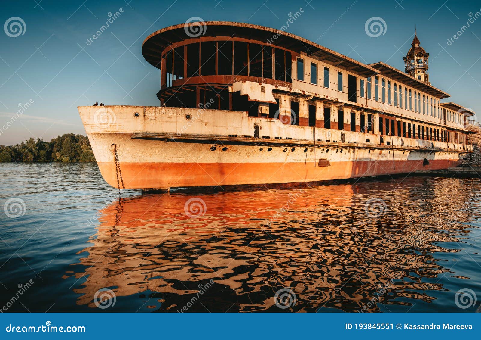 A Lighthouse in the Setting Sun. a Lighthouse and an Abandoned Ship in ...