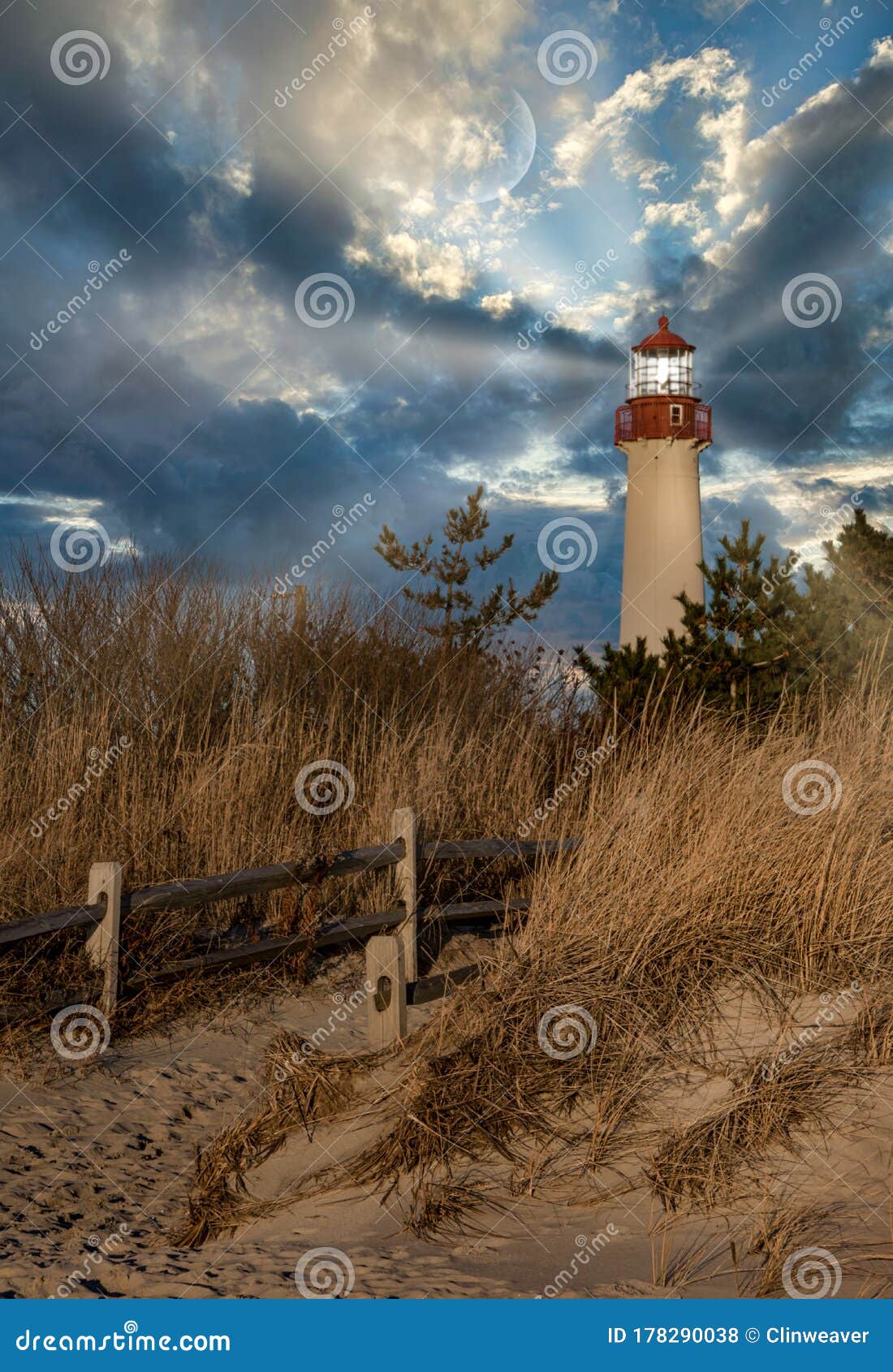 Lighthouse Shining Its Light Along the Seashore Under Cloudy Skies ...