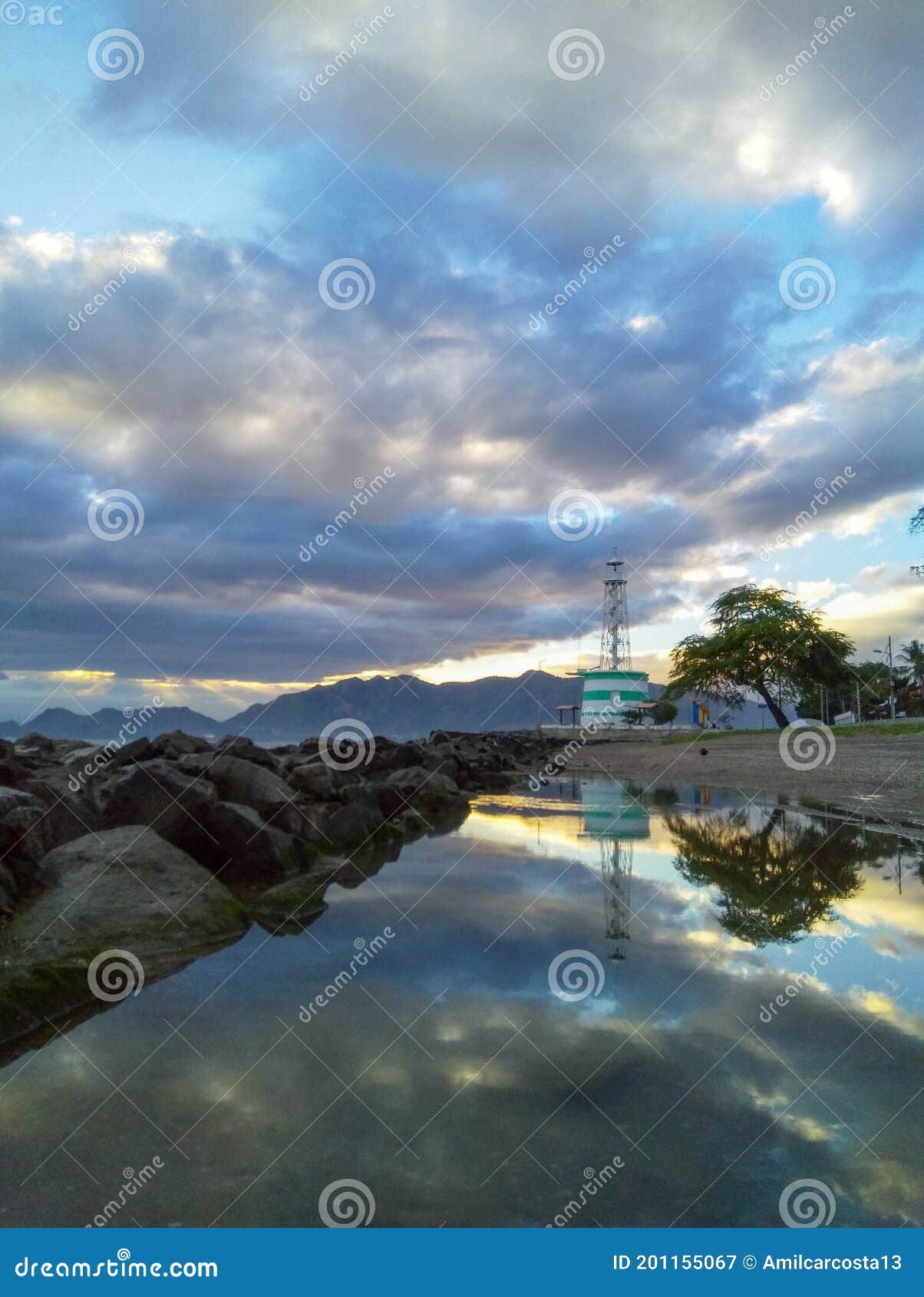 Lighthouse and Tree Reflection Combined with Blue Sky in Dili Harbor ...