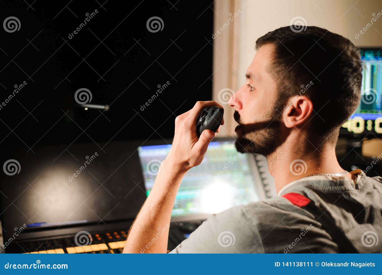A Lighting Engineer Works with Lights Technicians Control on the ...