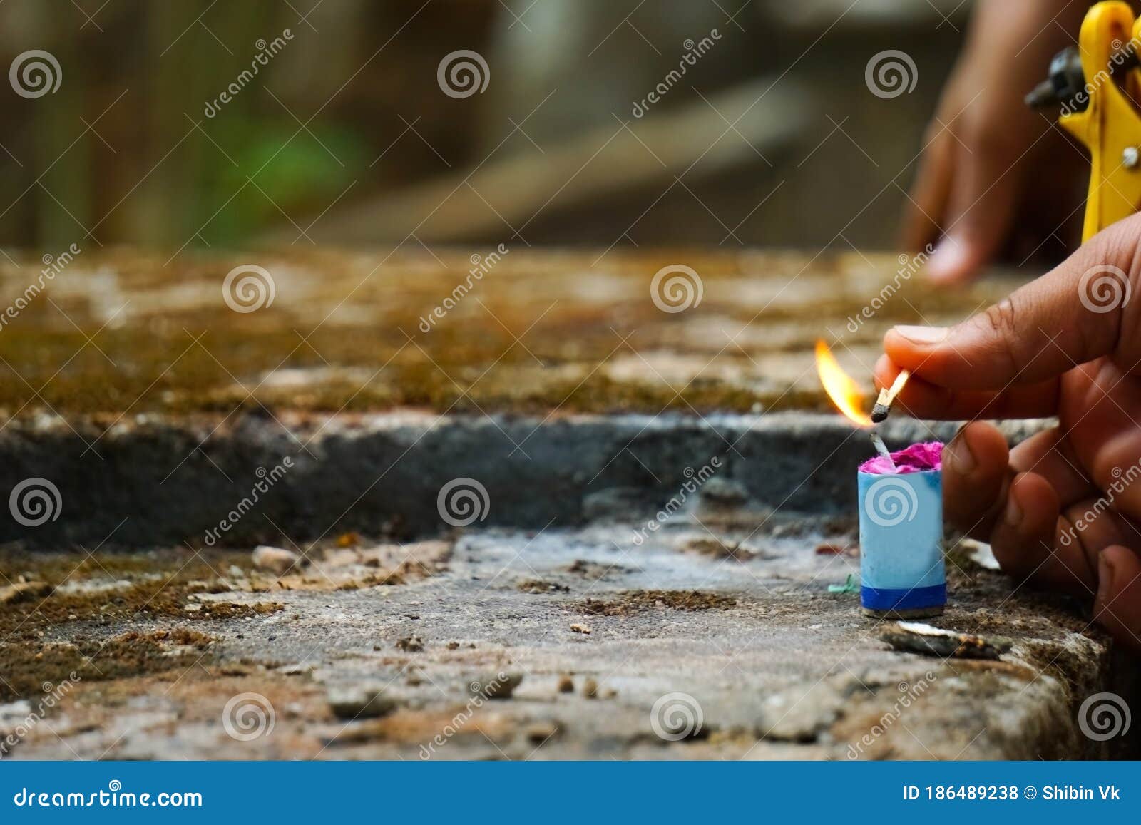 Lighting a firecracker. stock photo. Image of crackers - 186489238