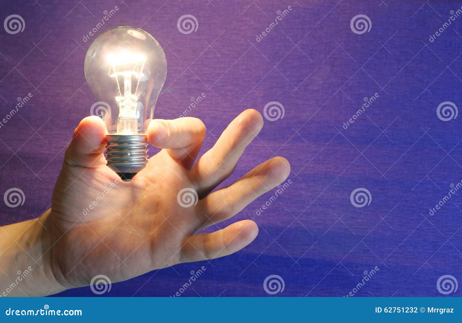 Lighting Lamp Flashing Bulb in Human Hand on Blue Background Stock ...
