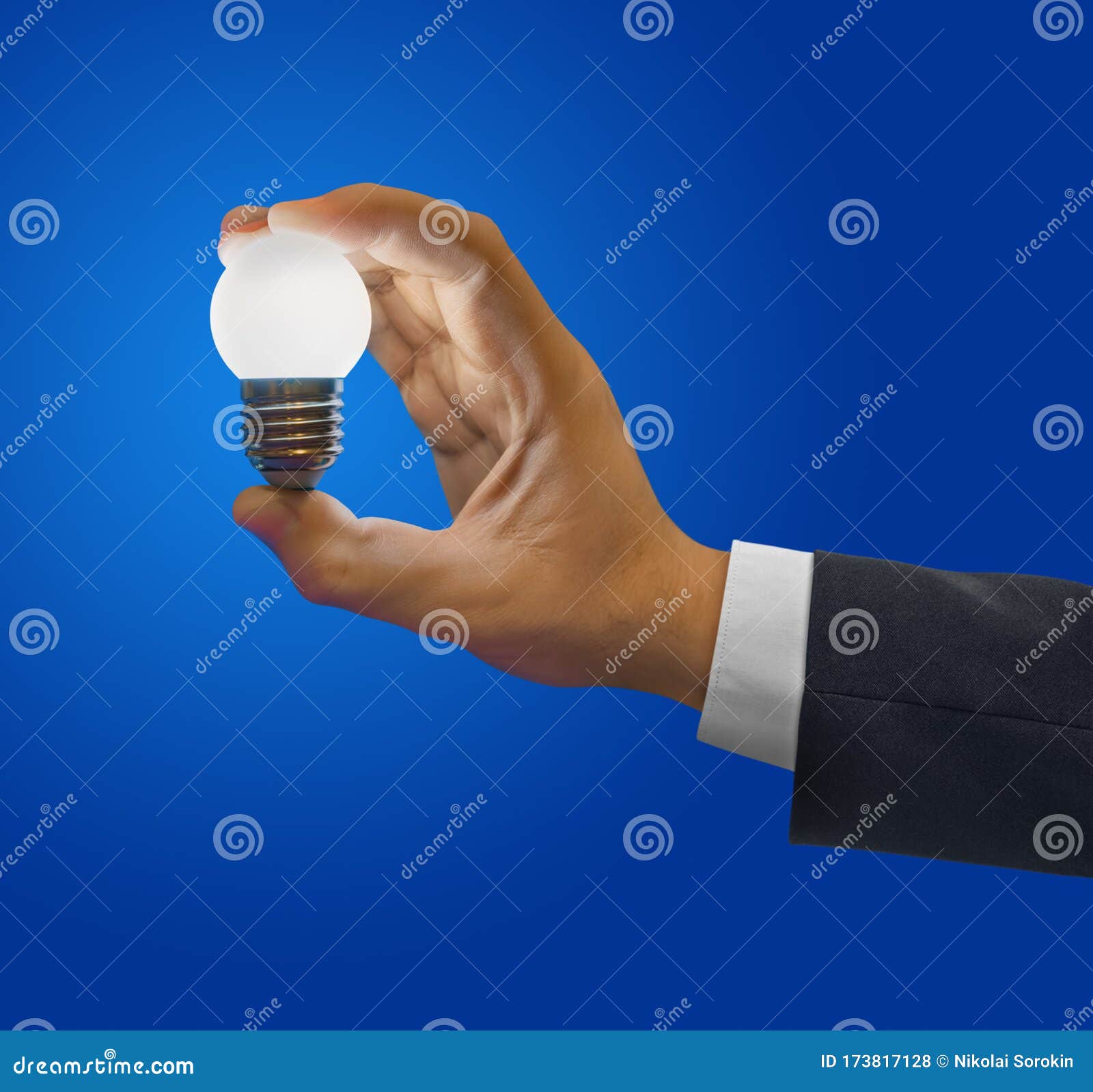 Lighting Lamp in Hand on Blue Stock Photo - Image of hand, bright ...