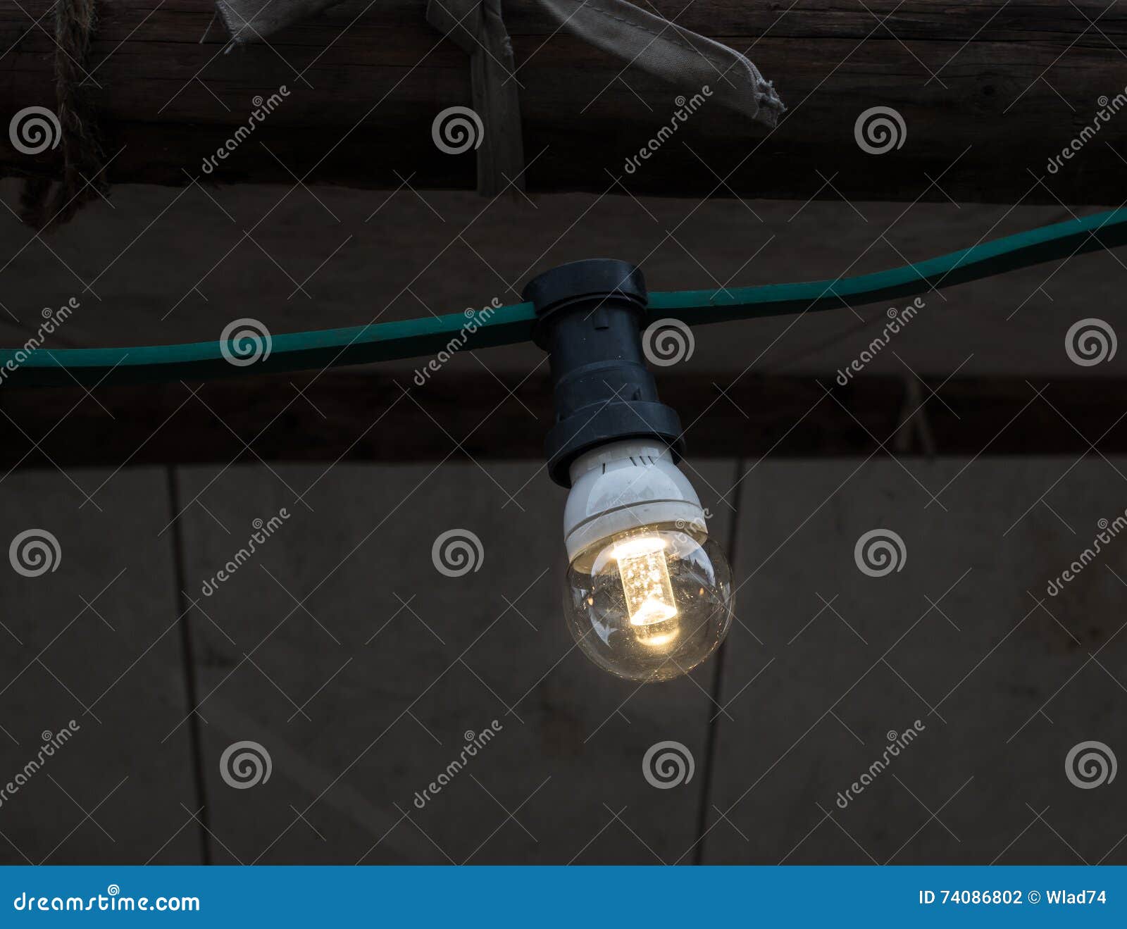 Lighting Light Bulb on the Cable at Dusk Stock Photo - Image of glowing ...