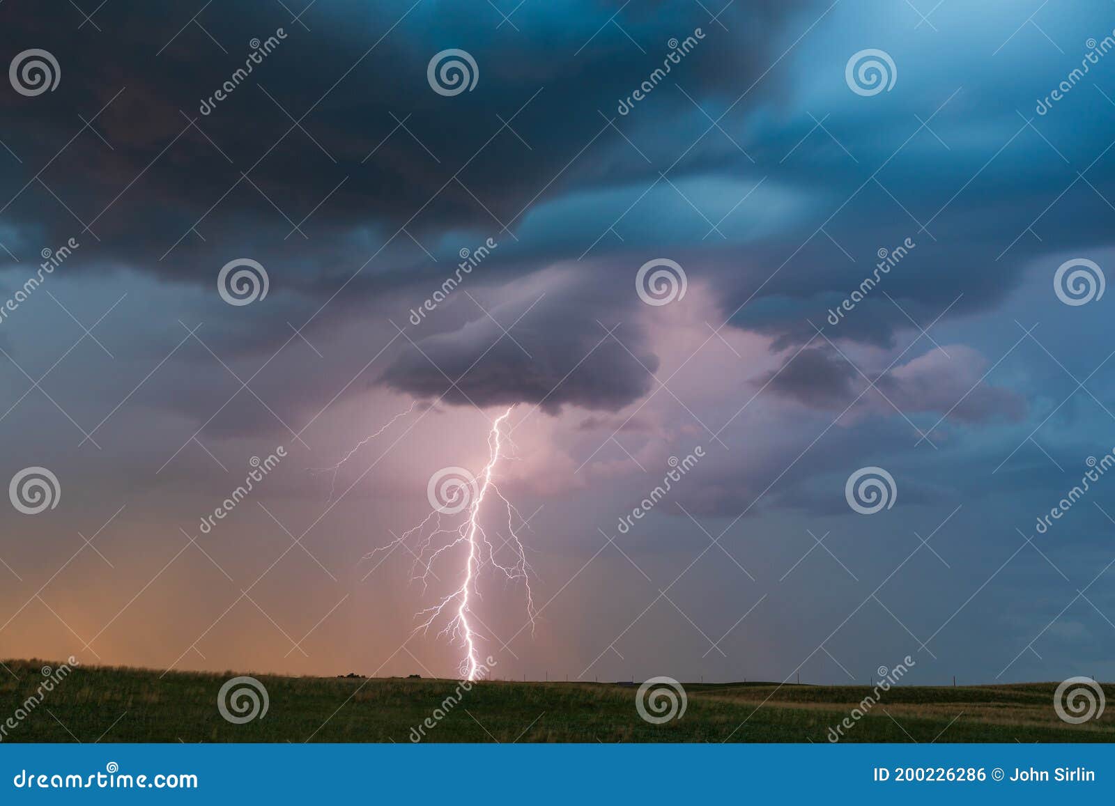 Lightning Bolt and Storm Clouds at Sunset Stock Photo - Image of flash ...