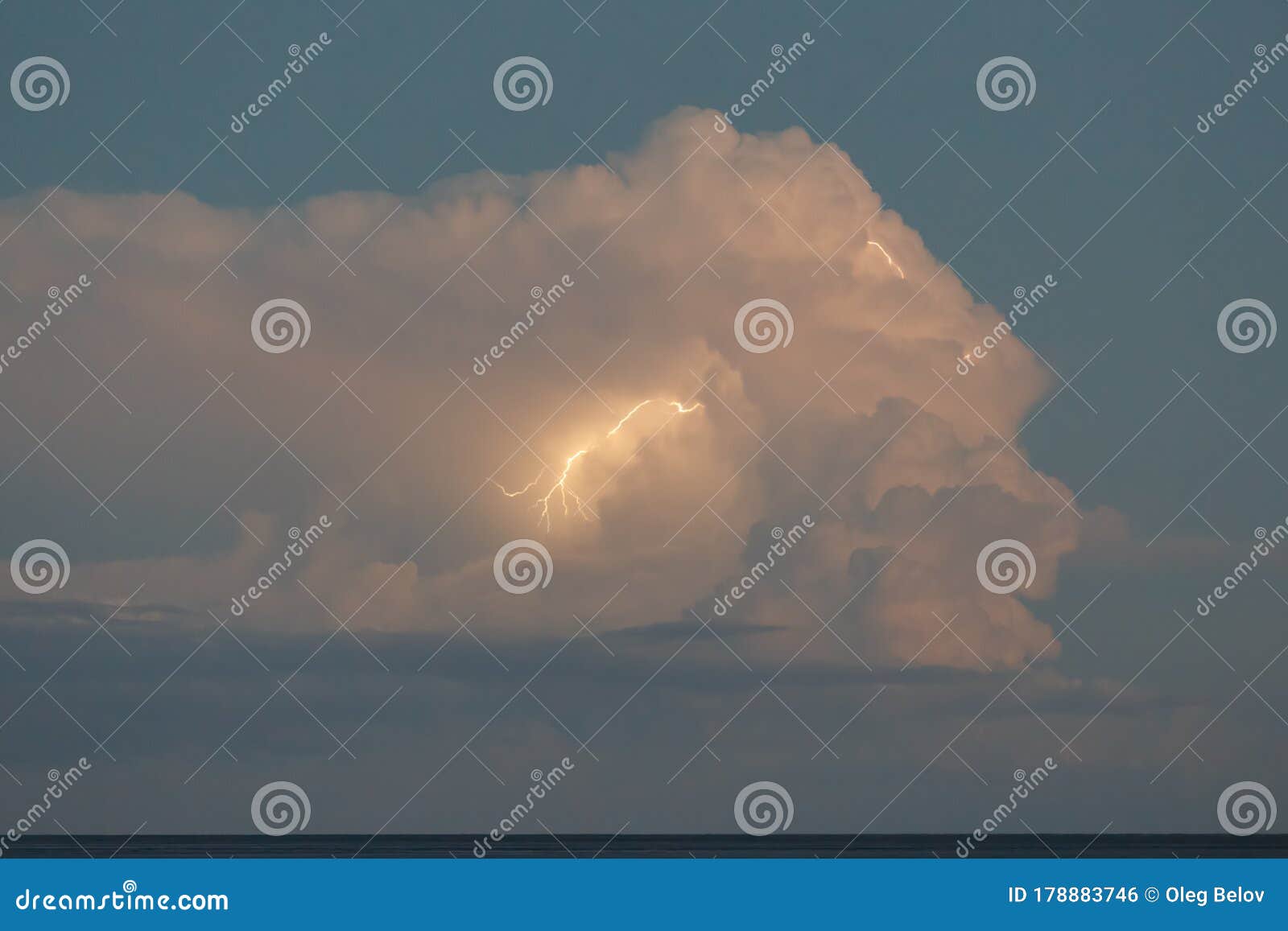 Lightning Flashes in a Thundercloud Above the Sea on a Summer Evening ...