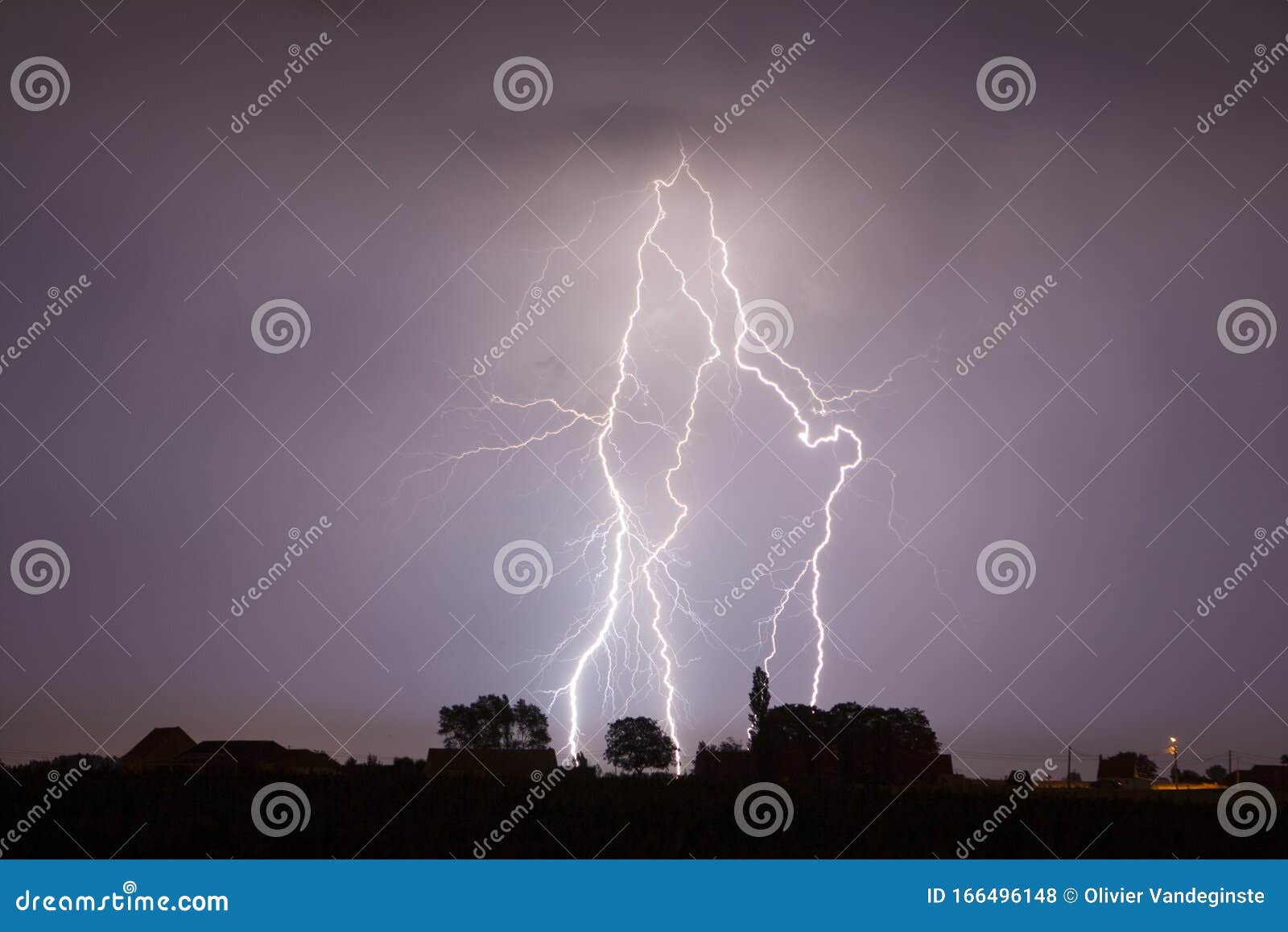Lightning in a Slow Moving Thunderstorm Over Trees. Stock Photo - Image ...