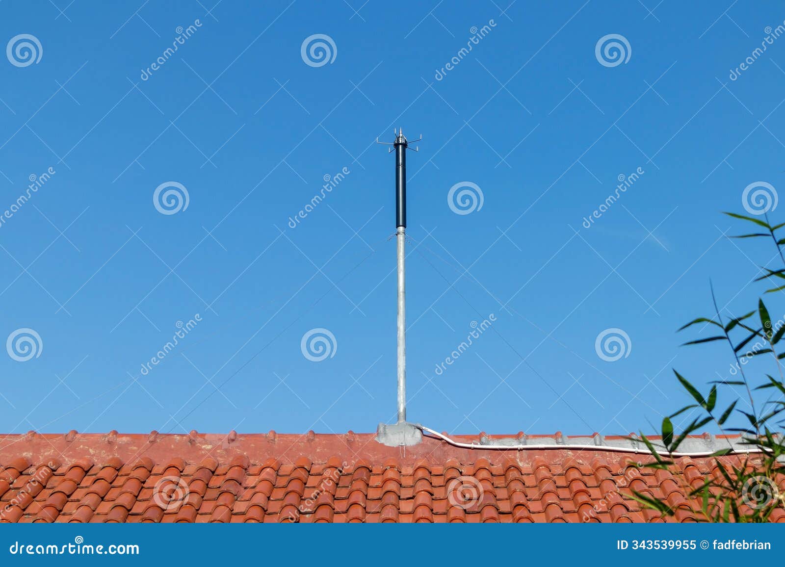 Lightning Rod on the Tile Roof of a Building with Blue Sky Background ...