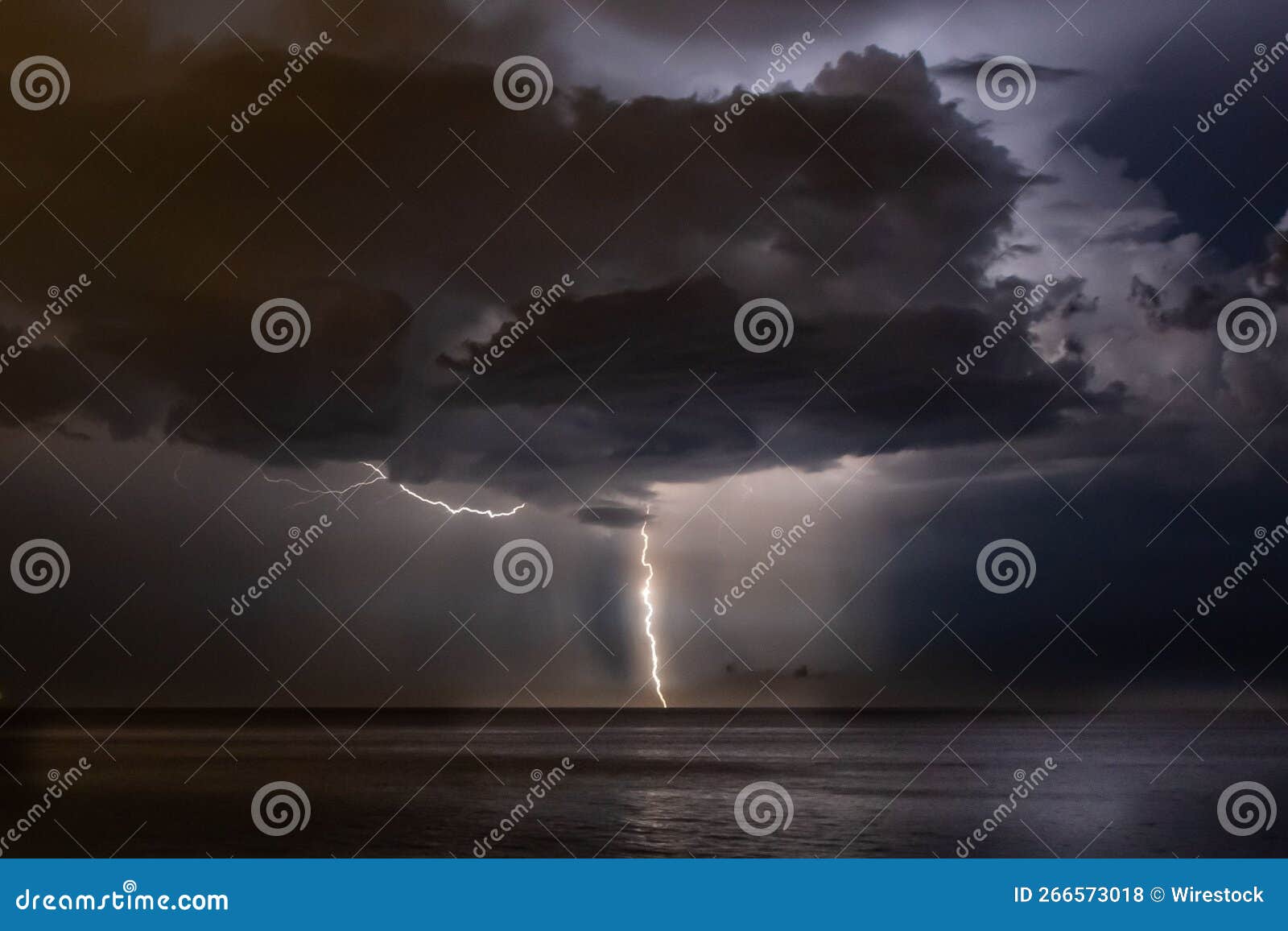 Lightning in a Stormy Night Sky Over a Seascape Hiding Behind the ...