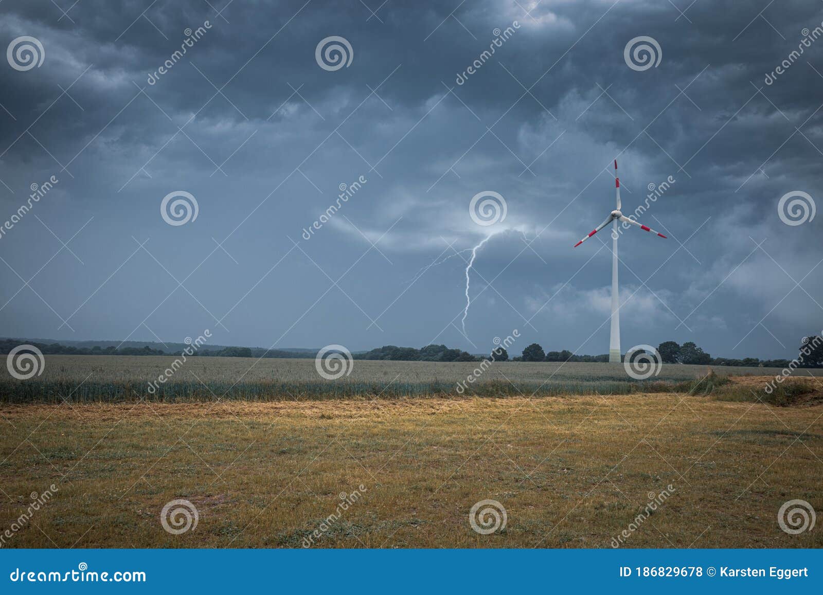 A Lightning Strikes the Ground Next To a Wind Turbine Stock Photo ...