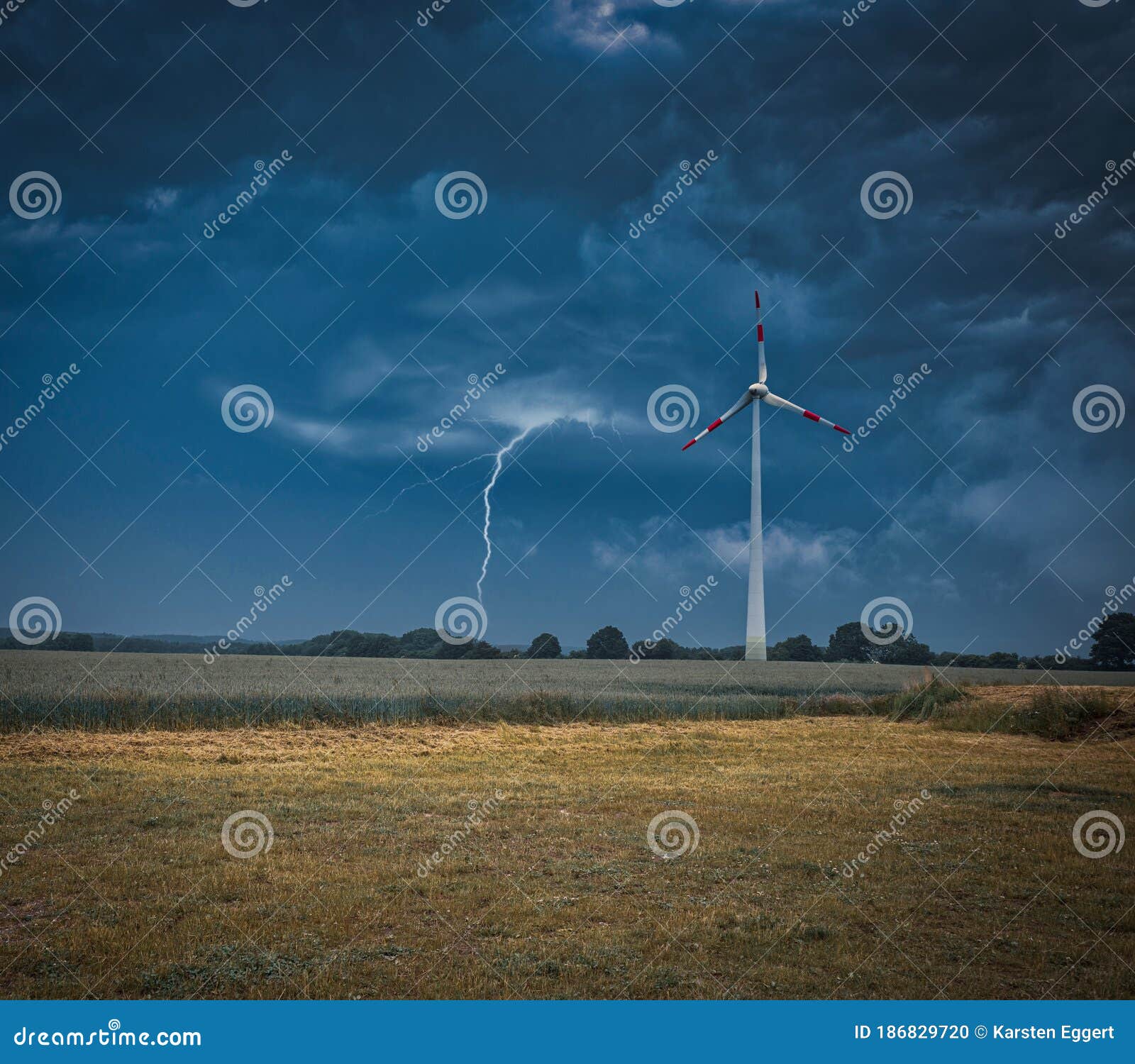 A Lightning Strikes the Ground Next To a Wind Turbine Stock Photo ...