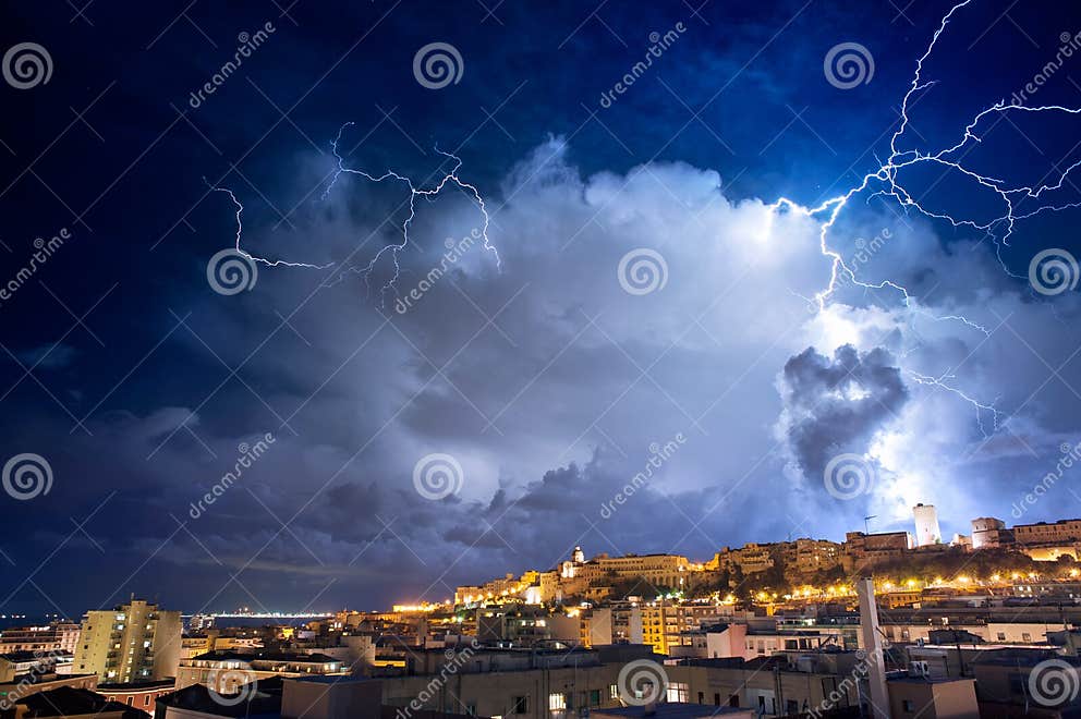 Cagliari Panorama at Night with Lightning Strikes Behind the City. Lightning Storm on Night Sky ...