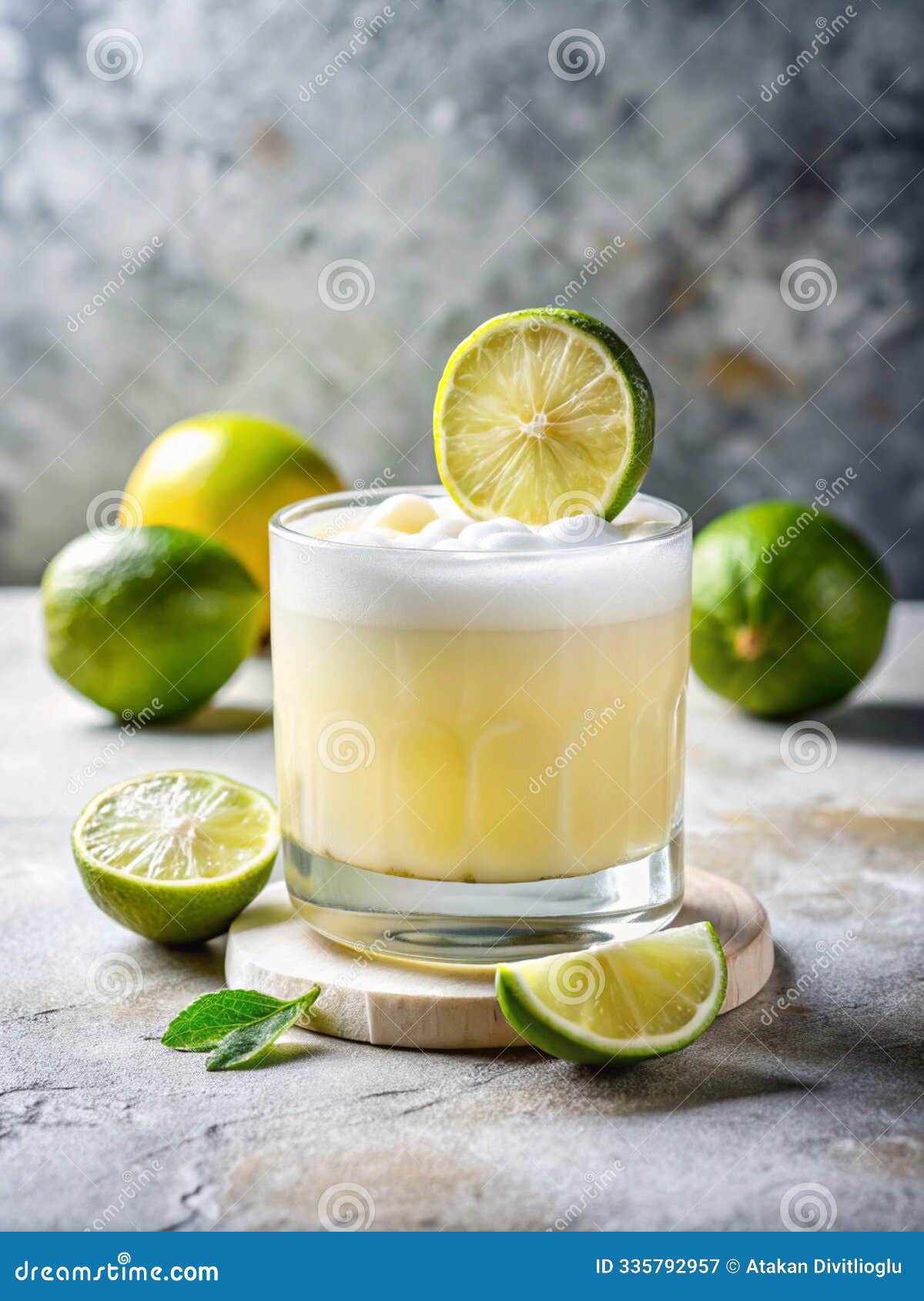 Lime Sour Cocktail in a Crystal Glass with Fresh Lime Garnish Stock ...