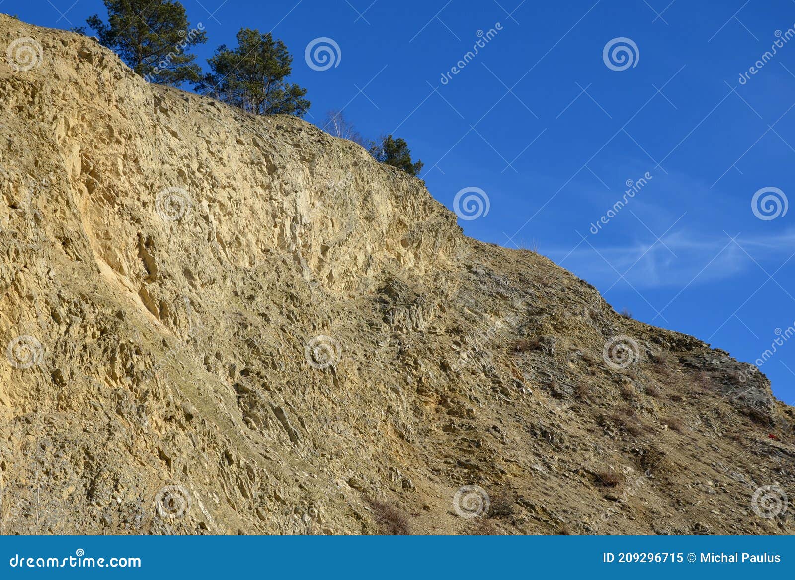 Limestone Cliff with Pine Trees on Top of a Rock. Yellow Weathered ...