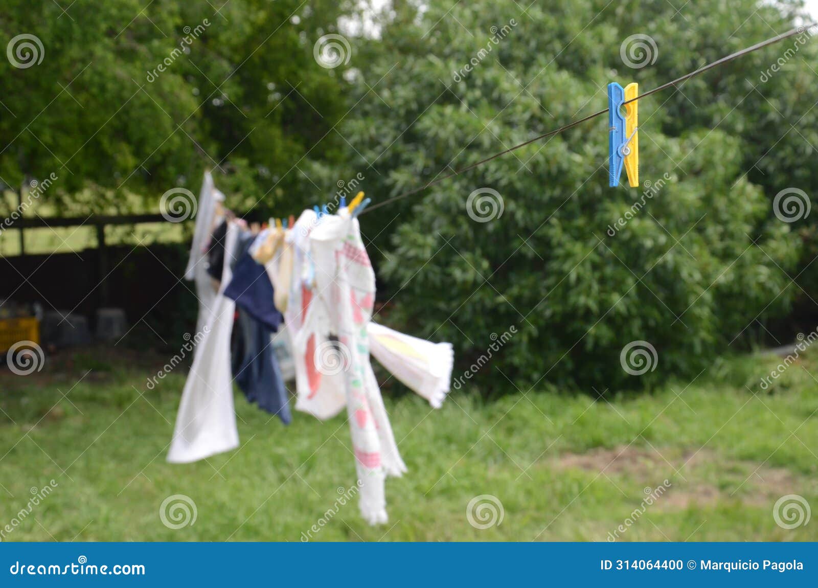 A Line of Clothes Hanging on a Clothesline Stock Photo - Image of hang ...