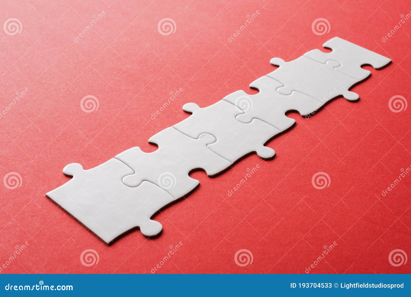 Line of Connected Jigsaw Puzzle Pieces on Red Stock Image - Image of ...
