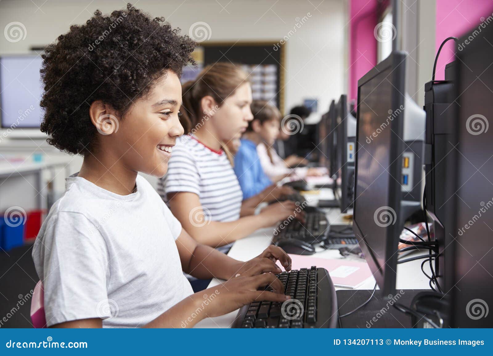 Line of High School Students Working at Screens in Computer Class Stock ...