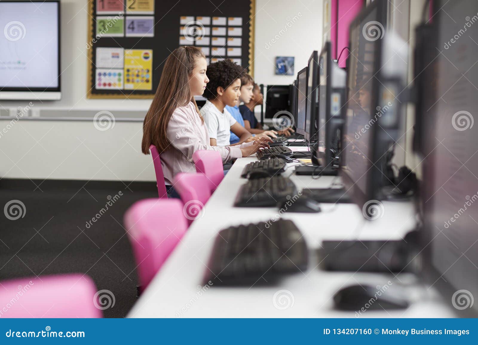 Line of High School Students Working at Screens in Computer Class Stock ...
