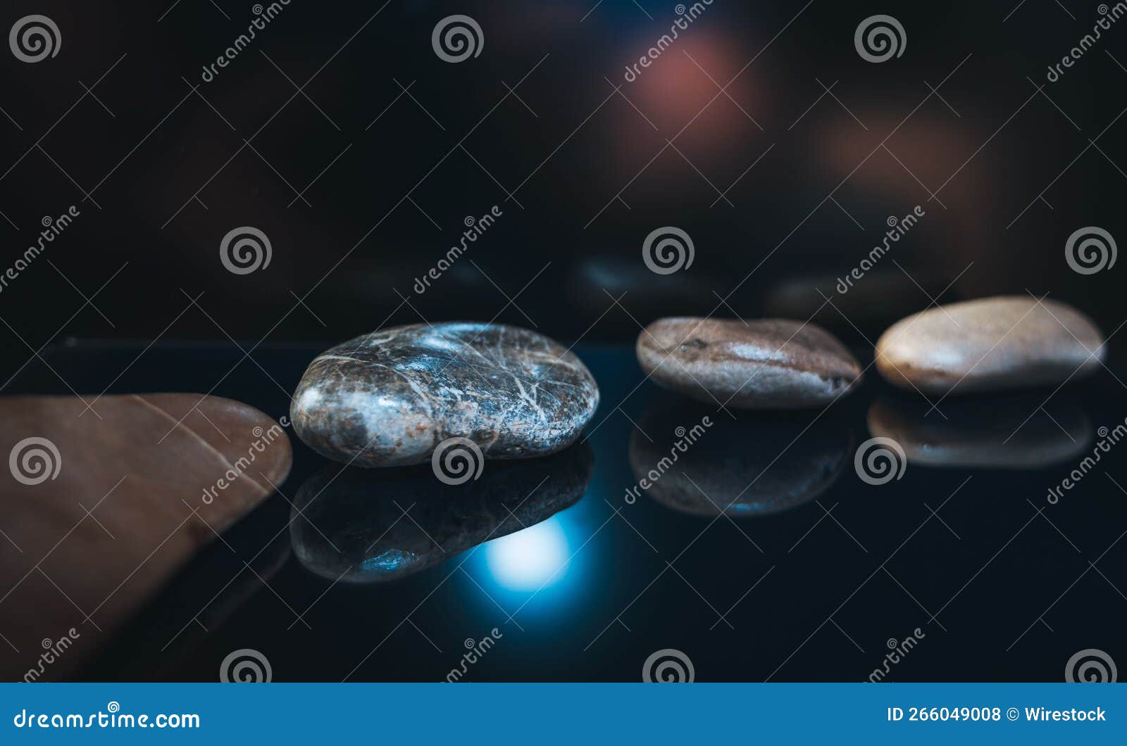 Line of Pebbles on a Dark Glowing Surface Stock Photo - Image of ...
