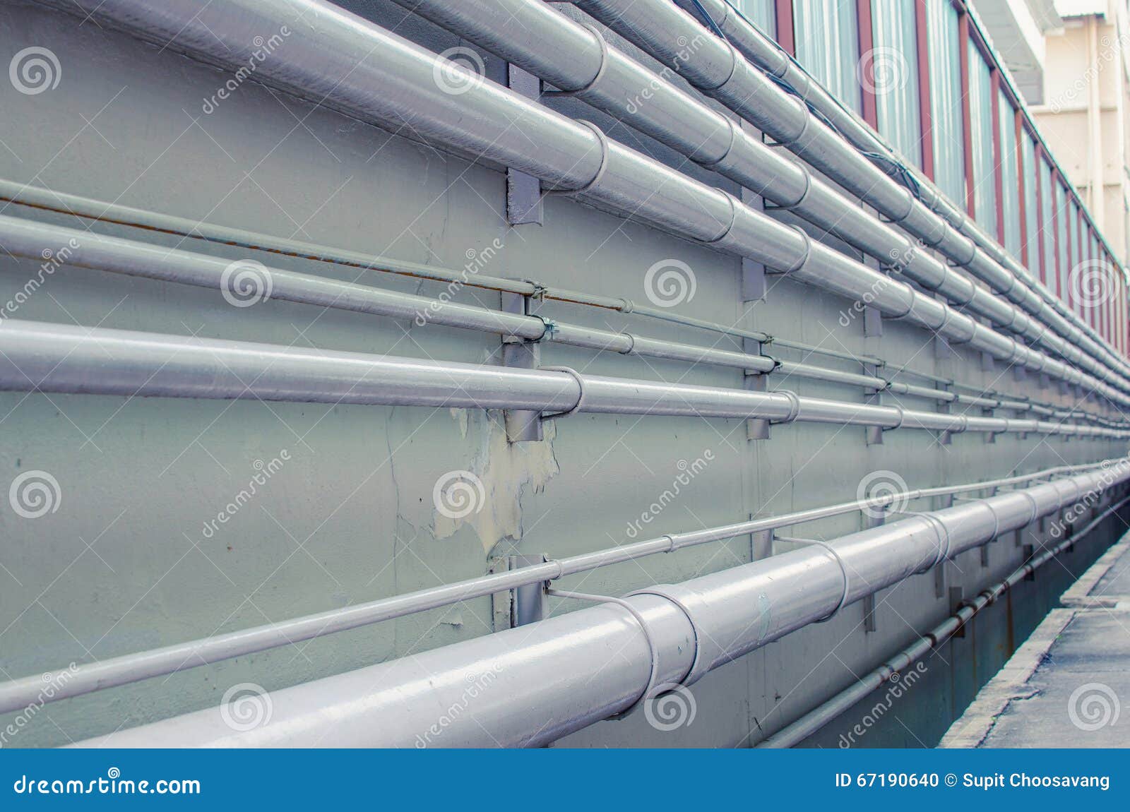 Line of pipe on wall stock photo. Image of pipe, support - 67190640
