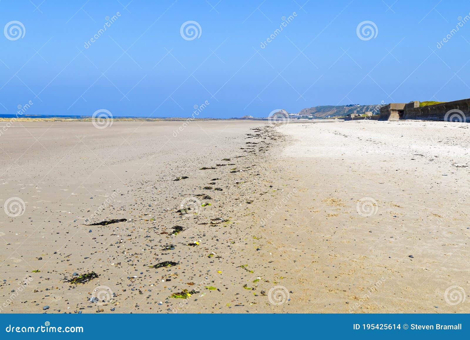 A Line of Seaweed and Shells Shows the High Tide Mark on a Beach in ...
