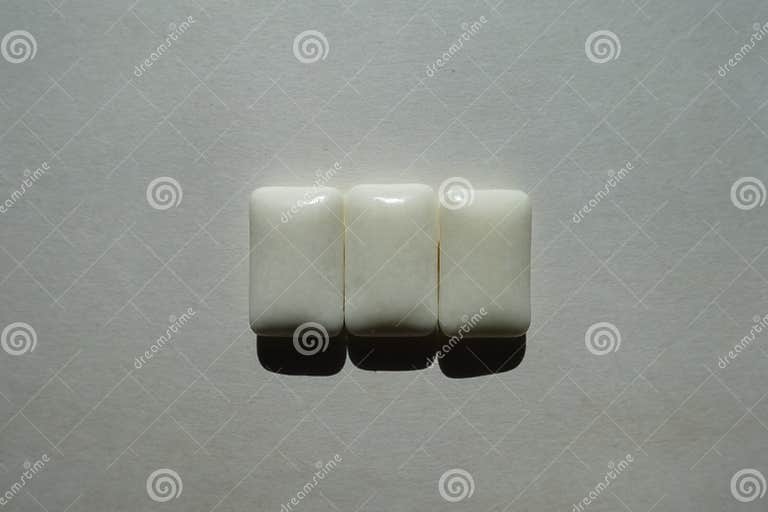 Line of Three White Pieces of Chewing Gum Stock Image - Image of ...