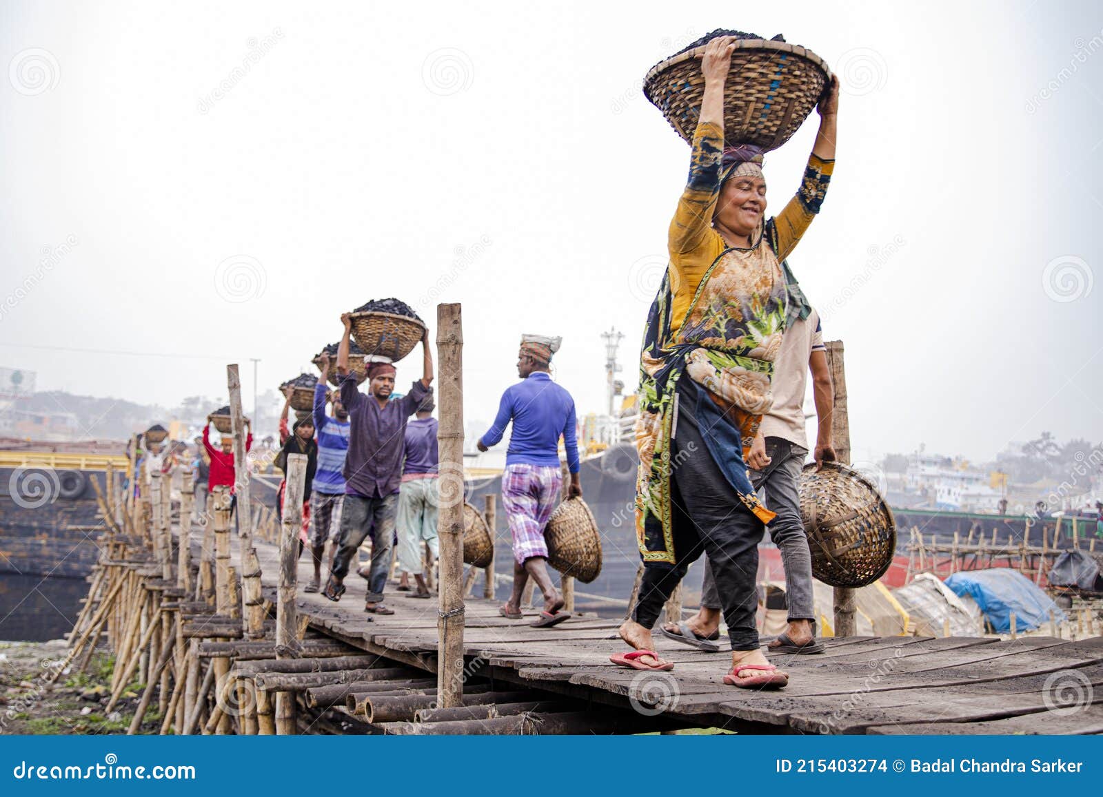 A Line of Workers Carrying the Heavy Loads of Coal in Baskets Editorial ...