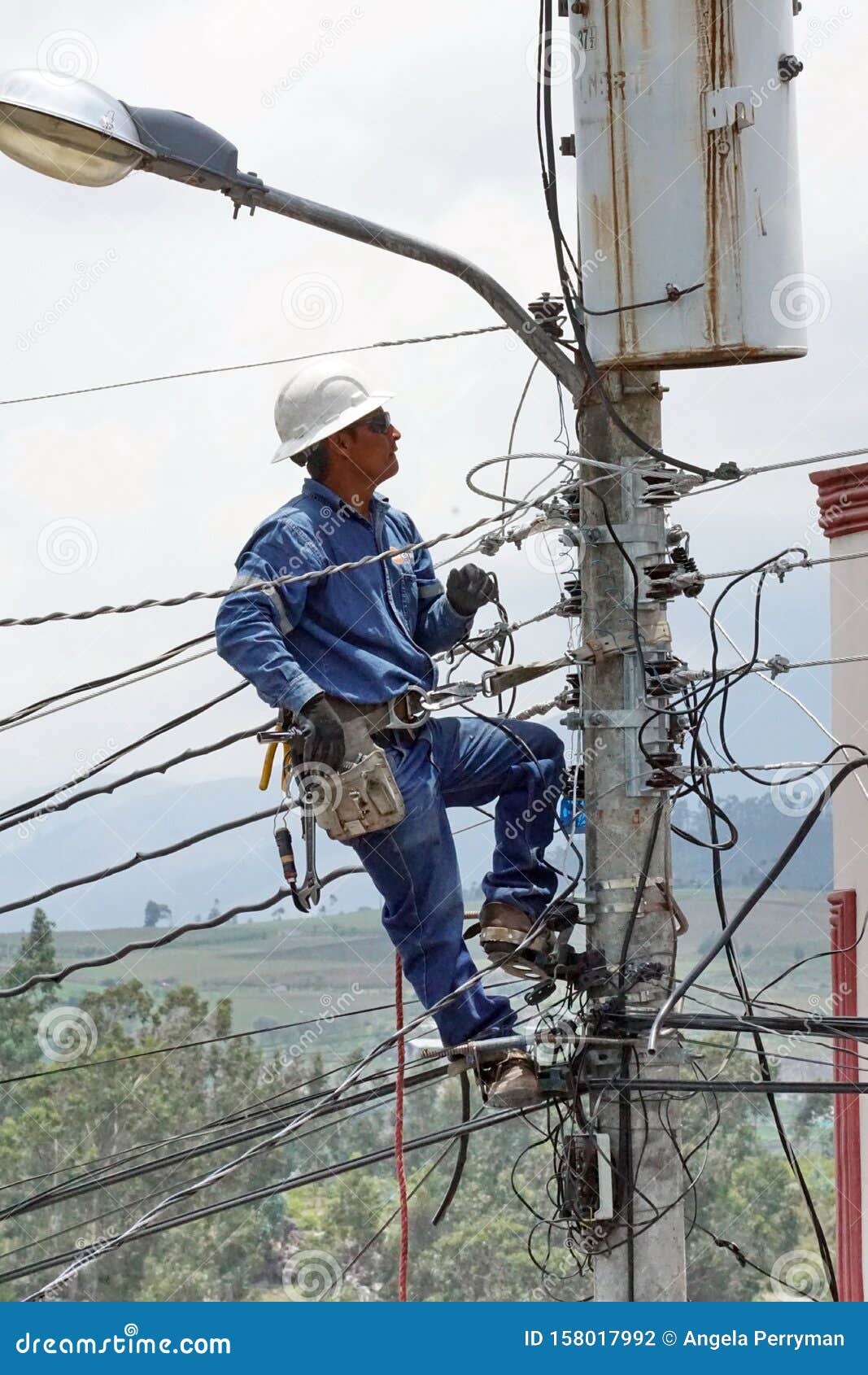 Lineman on a power pole editorial photography. Image of lineman - 158017992