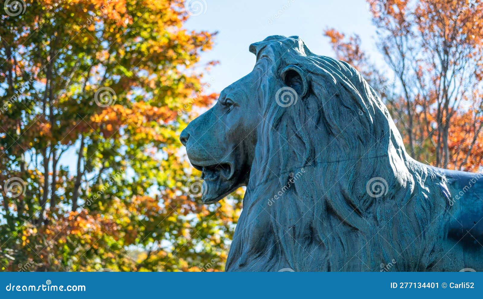 Lion Statue on a Backdrop of Trees in Fall Stock Image - Image of ...