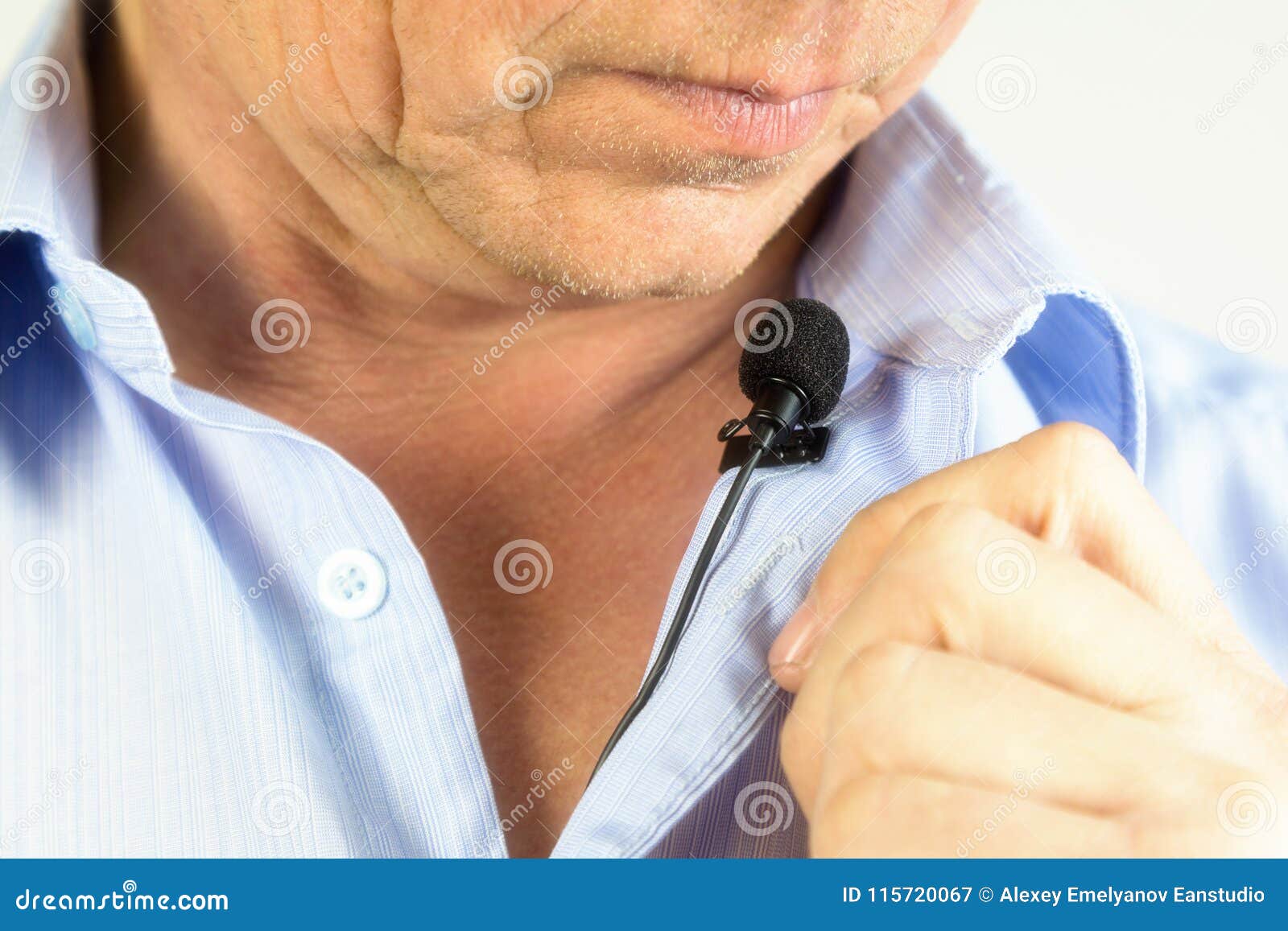 The Man Speaks into a Small Microphone in a Low Voice. Stock Image ...