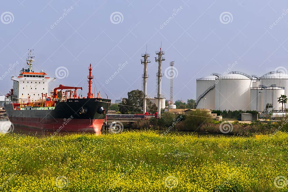 Liquid Bulk Merchant Ship Moored in a Dock of a River Port Next To Some ...