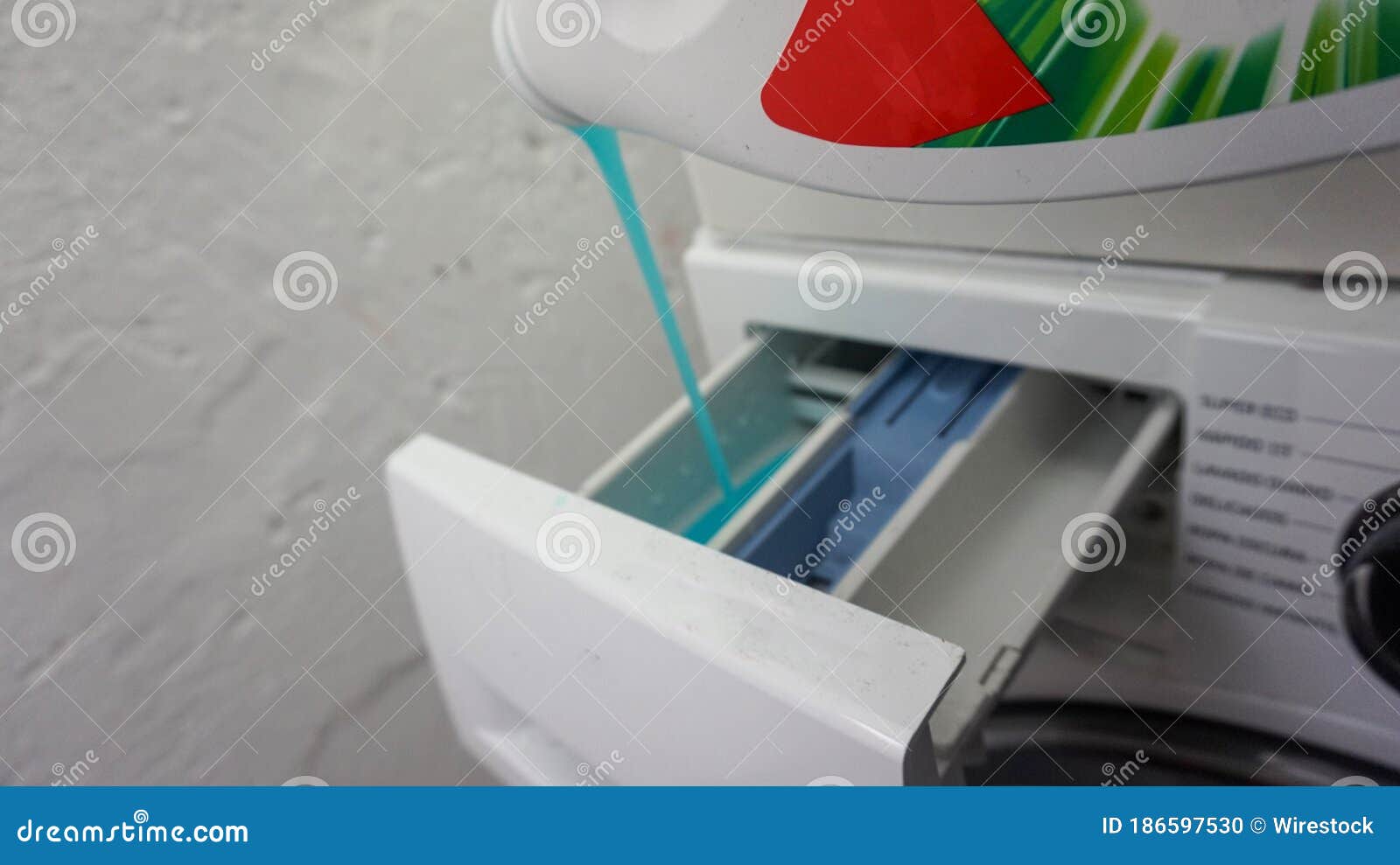 Liquid Laundry Detergent Pouring into the Washing Machine Stock Photo ...