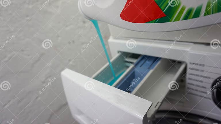 Liquid Laundry Detergent Pouring into the Washing Machine Stock Photo ...