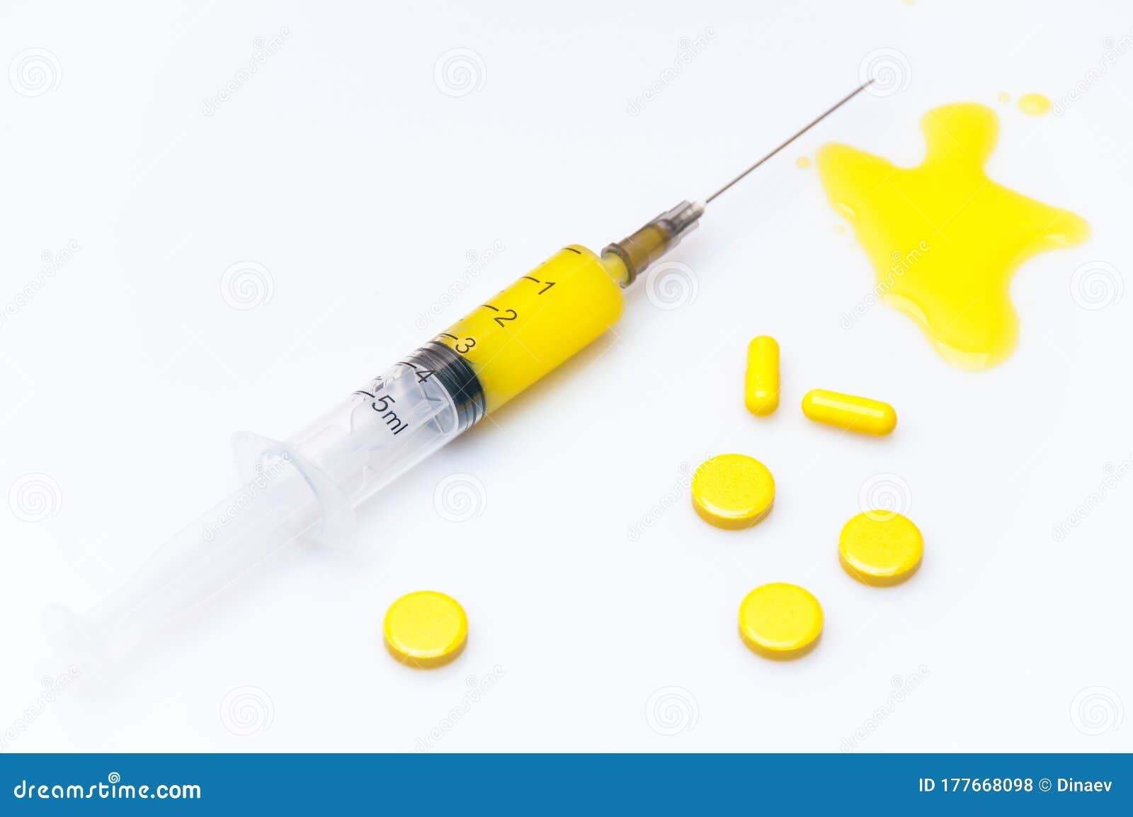 A Medical Syringe with a Yellow Solution Lies on a White Background ...