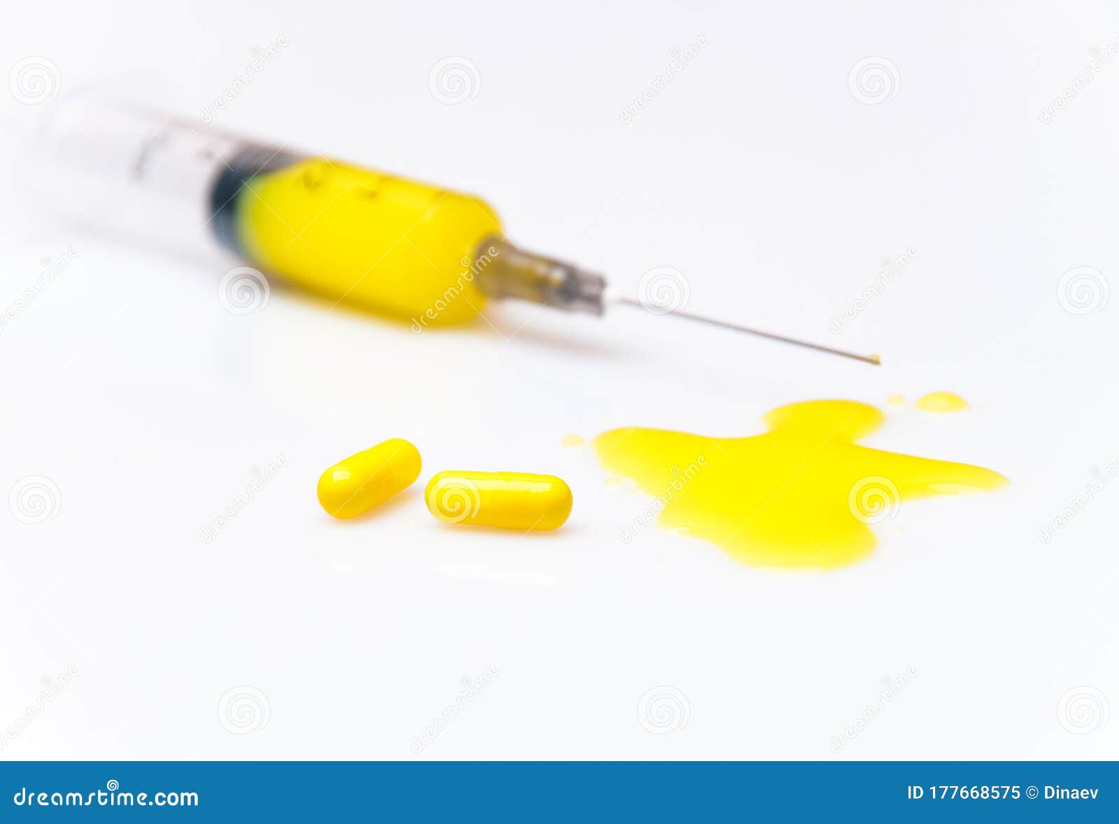 A Medical Syringe with a Yellow Solution Lies on a White Background ...
