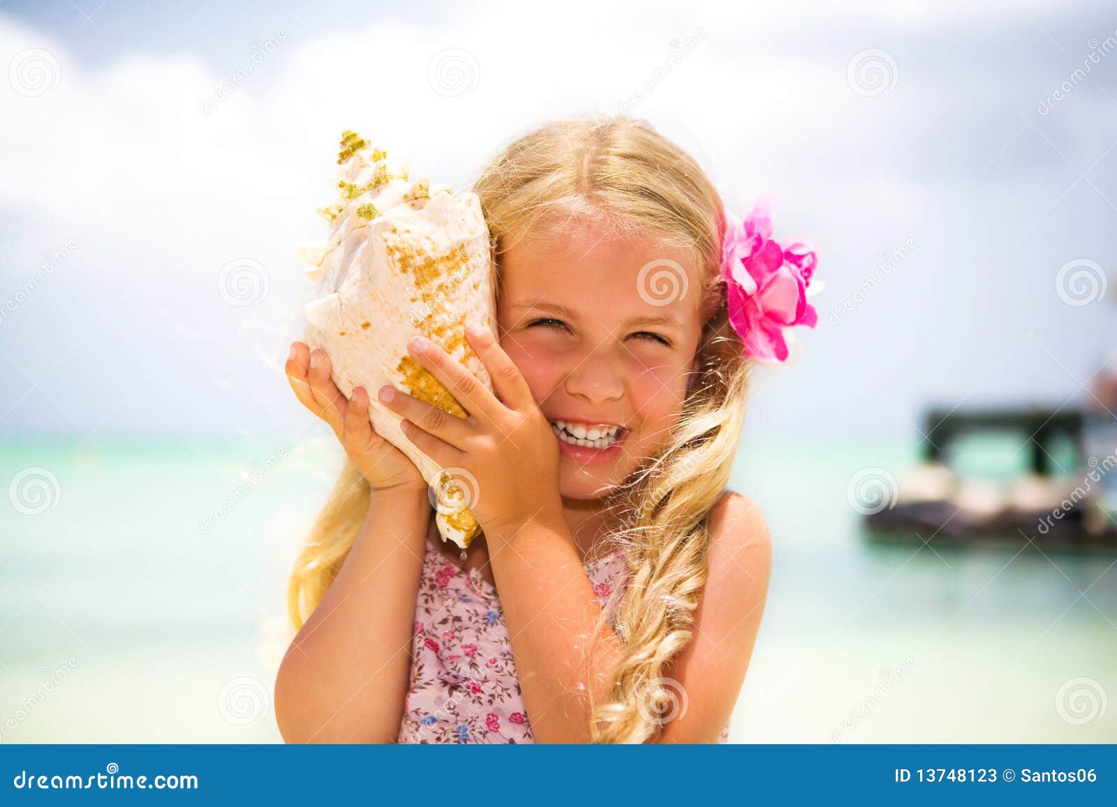 Listening to a seashell stock image. Image of bright - 13748123