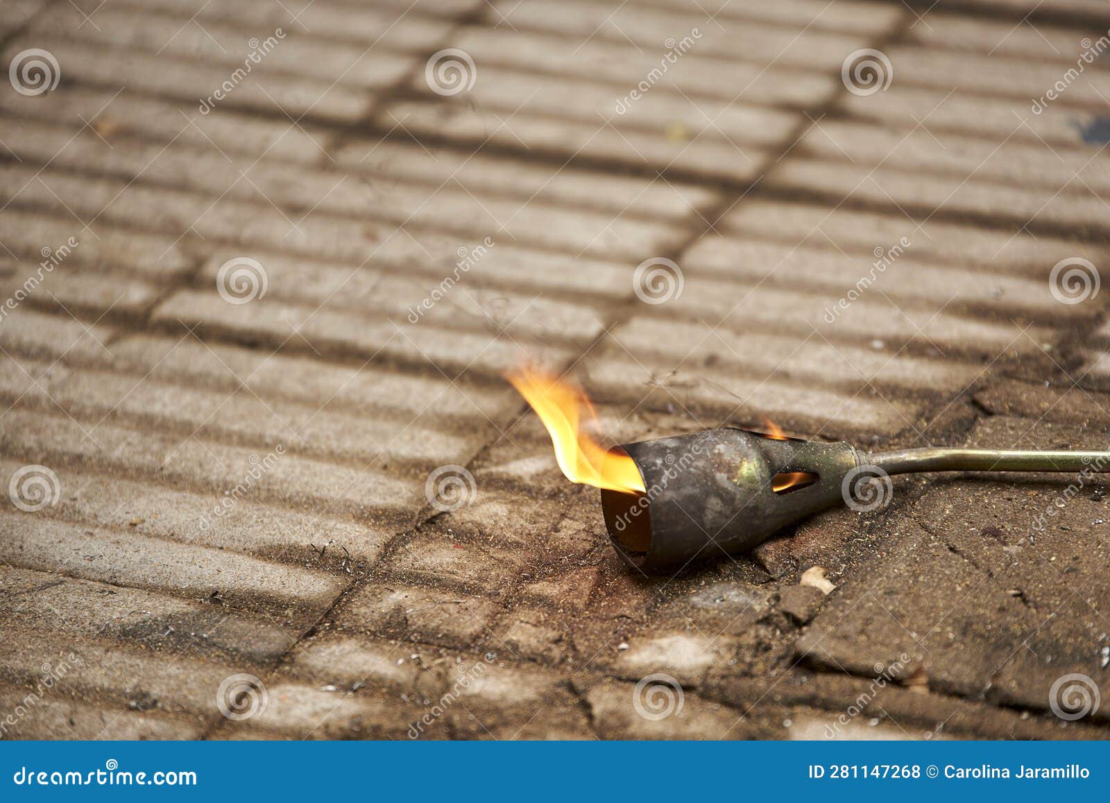 Lit Blowtorch, Throwing Fire Leaning on the Ground. Composition with ...