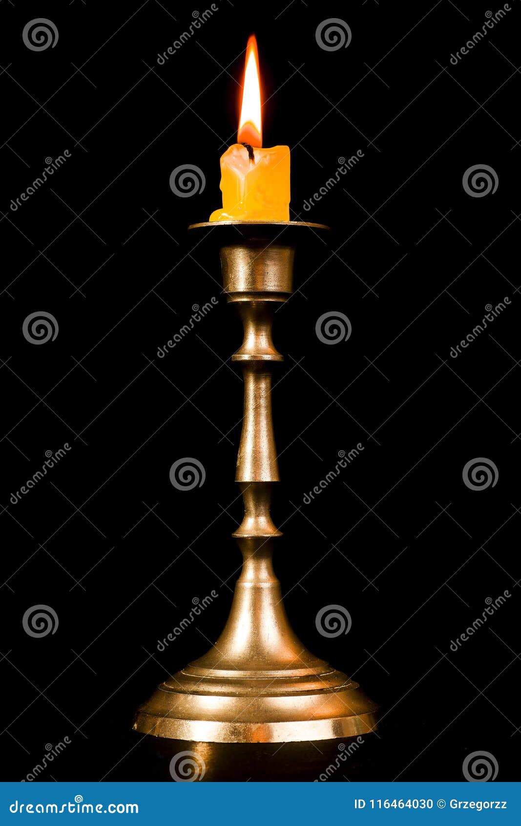 Lit Candle on a Brass Candlestick Stock Photo - Image of black, yellow ...