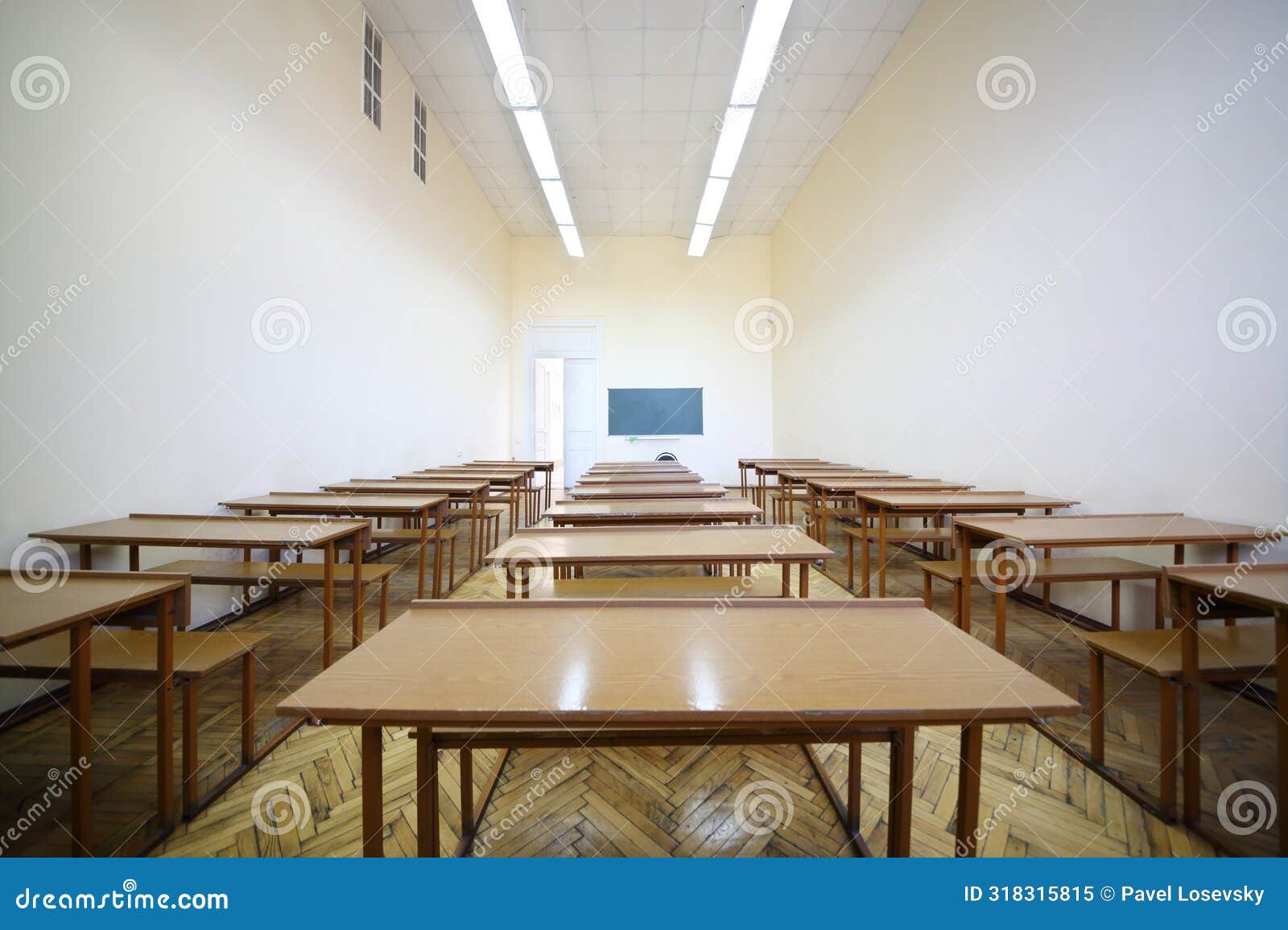 Lit Classroom with Rows of Wooden Tables for Stock Image - Image of ...