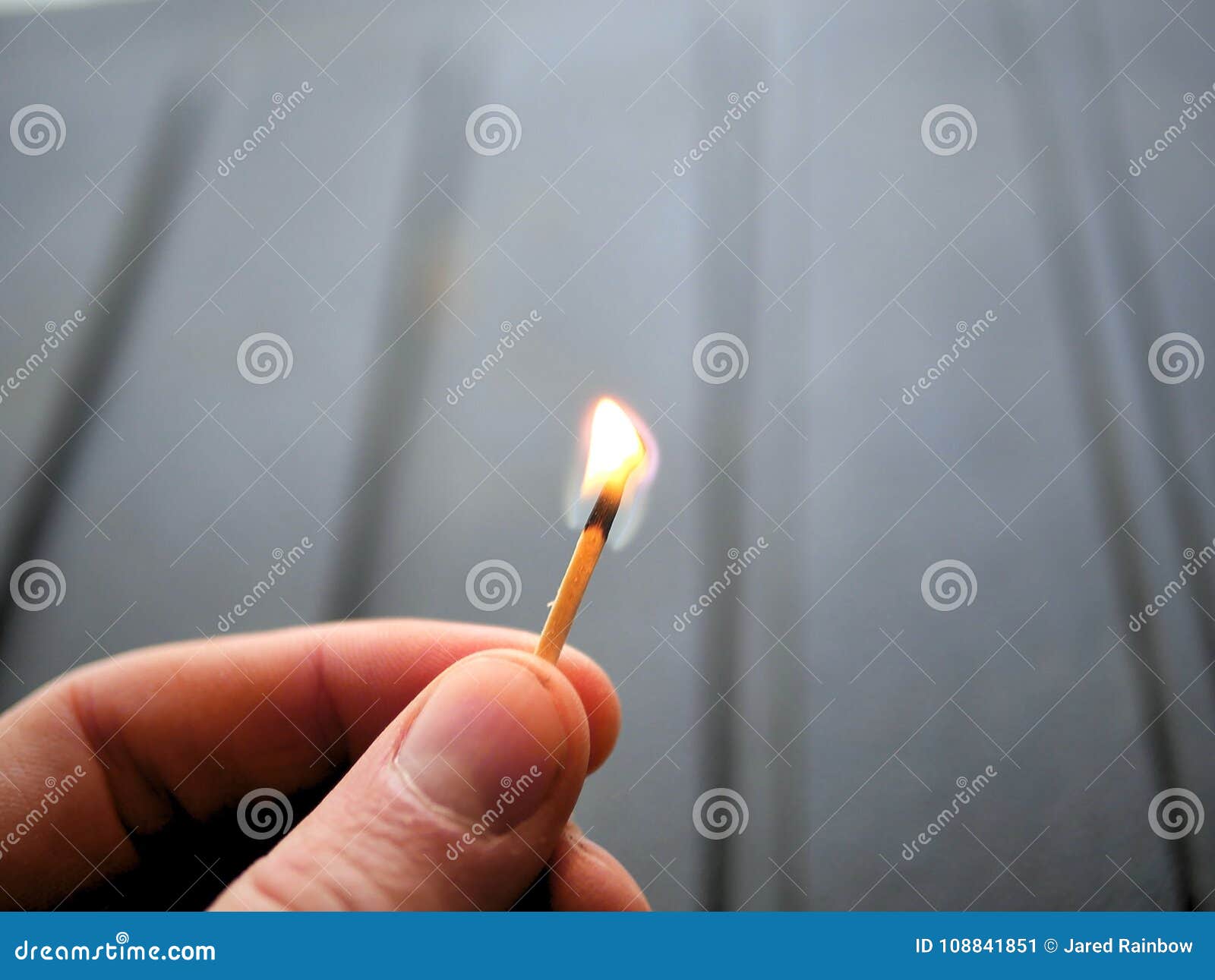 Lit Match Held in Hand on Black Rugged Background. Stock Image - Image ...